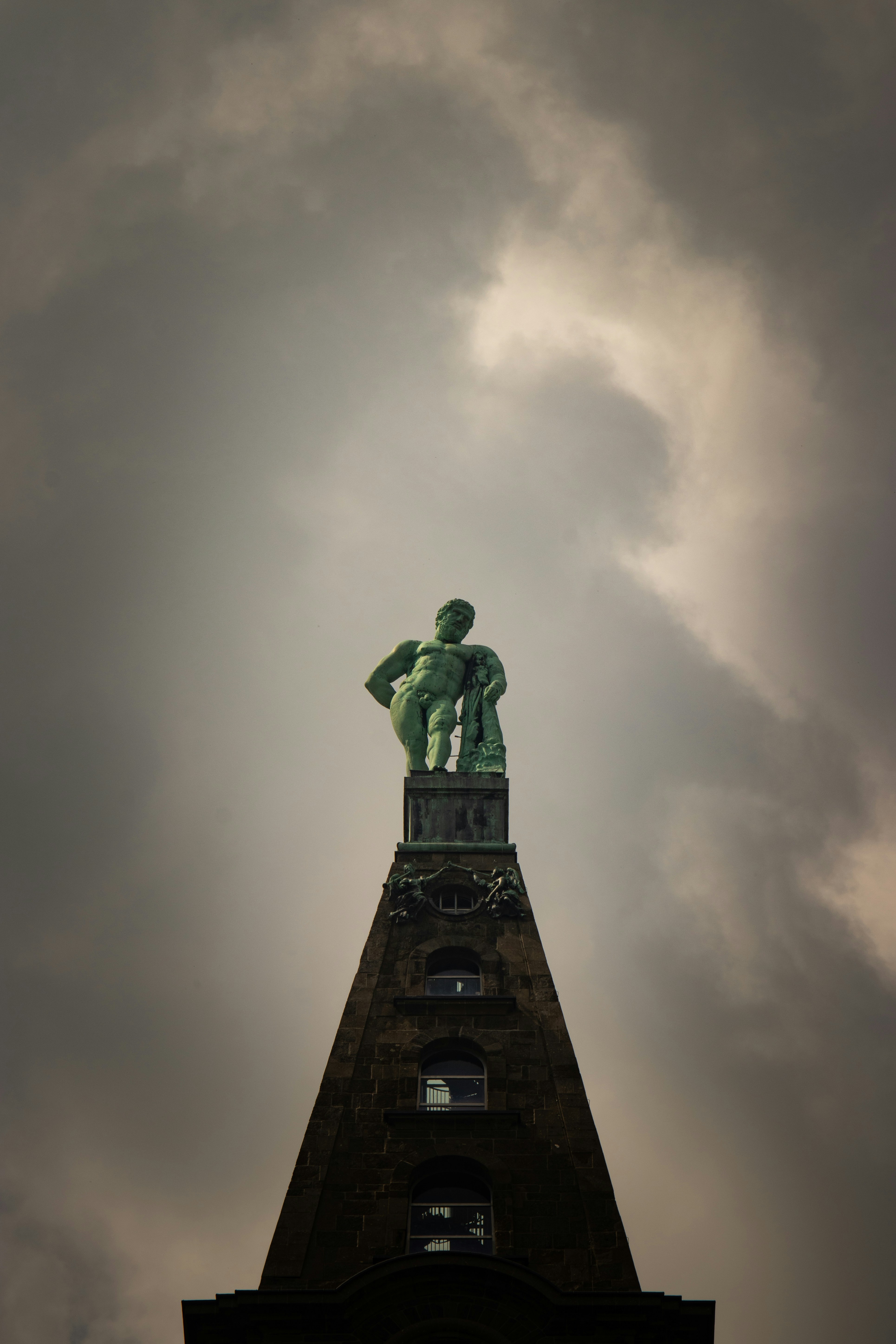 Patina Sentinel Above a Darkened Spire