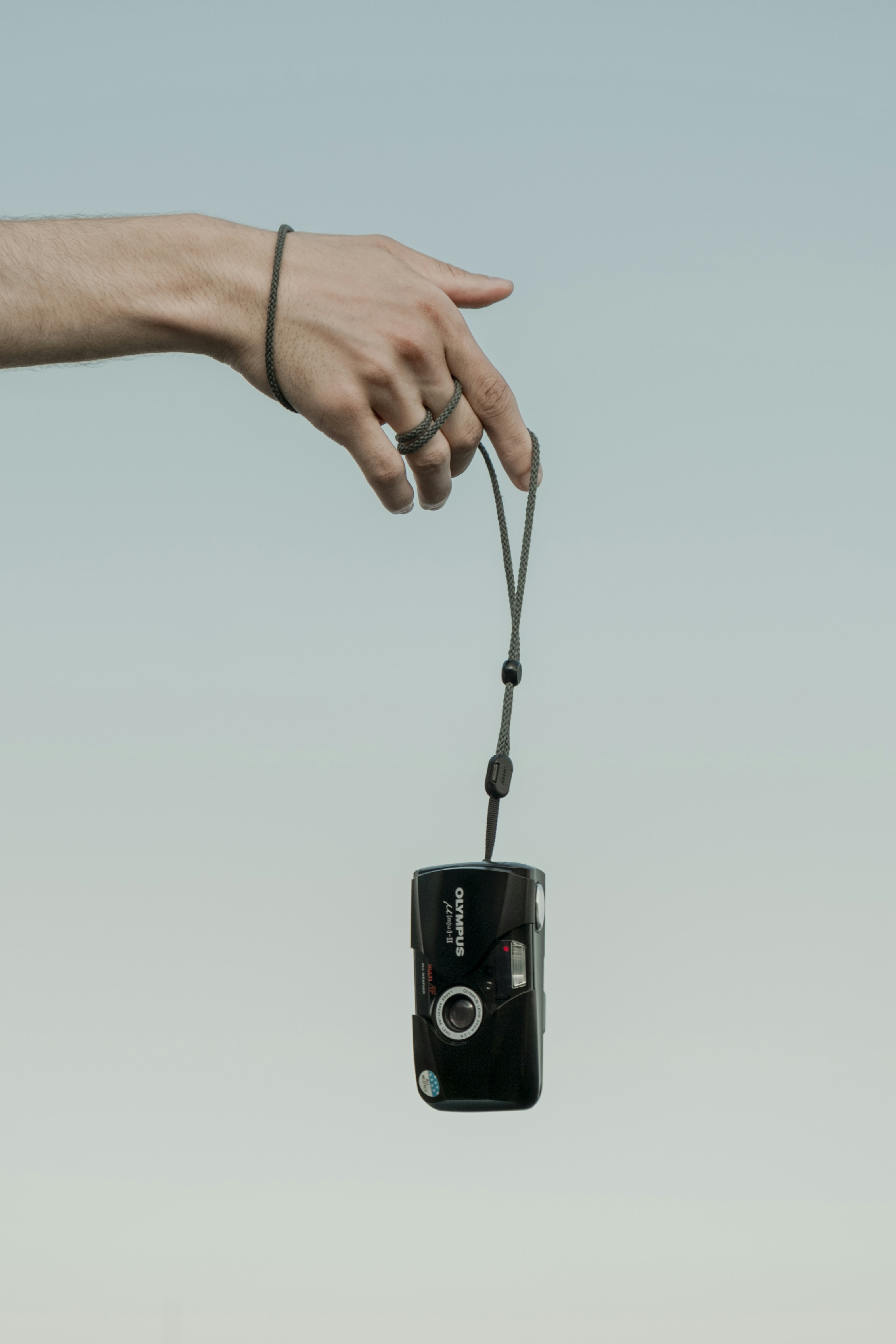 A hand holding a camera attached to a string photo – Free Finger Image ...