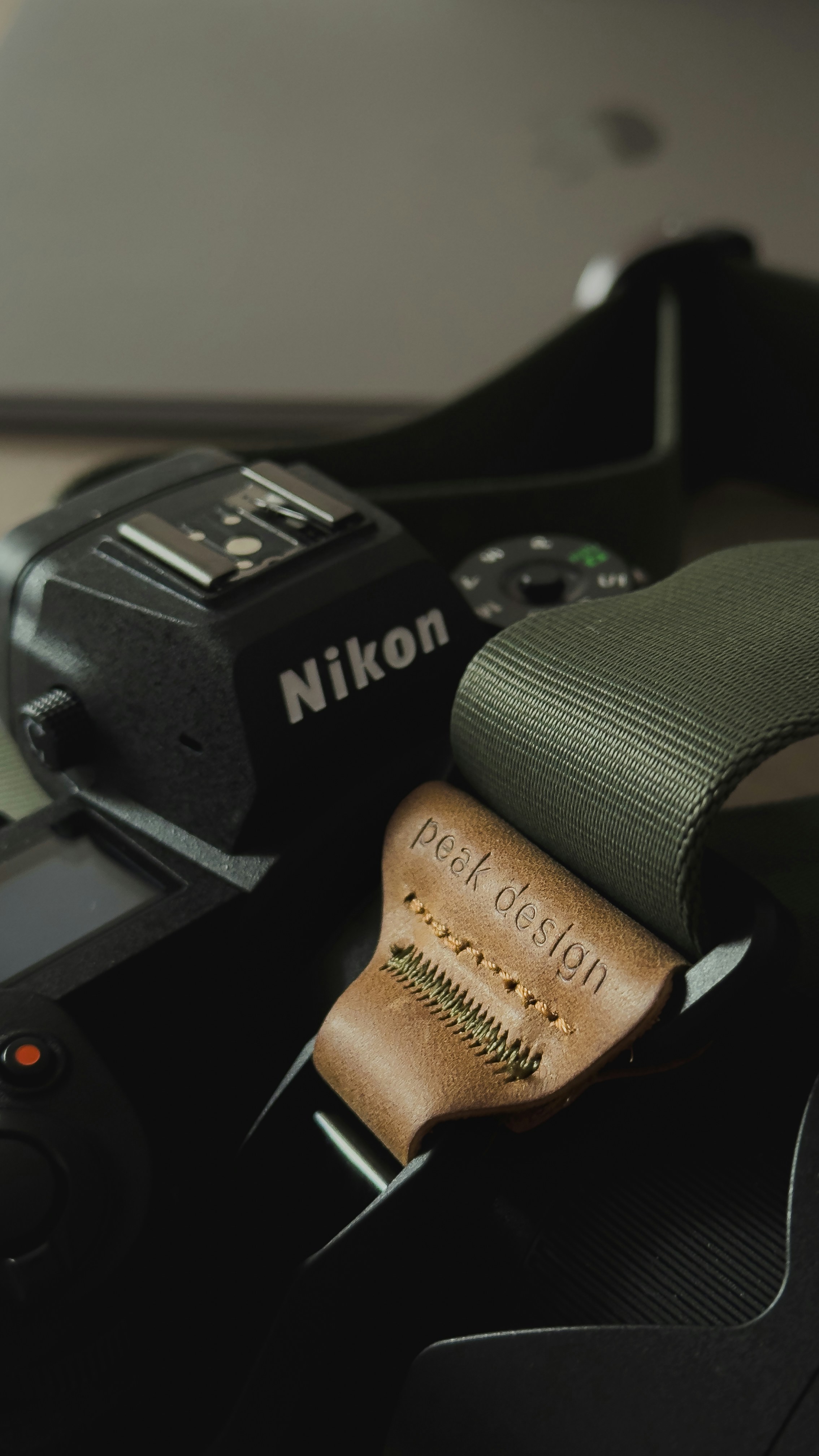 Nikon DSLR Close-Up: Leather Peak Design Strap Framing a Textured Moment