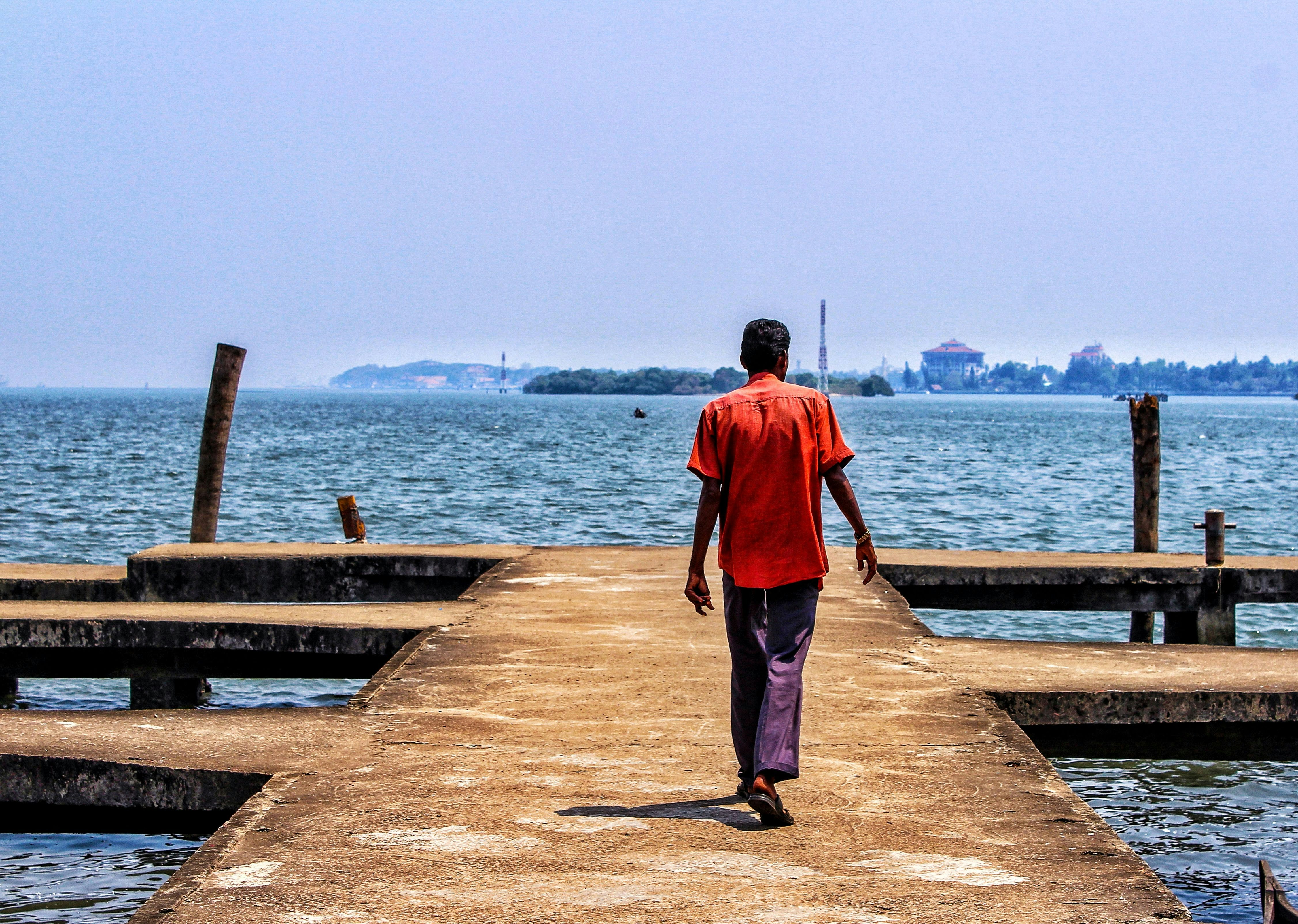 Red on the Pier: A solitary stride toward the blue horizon