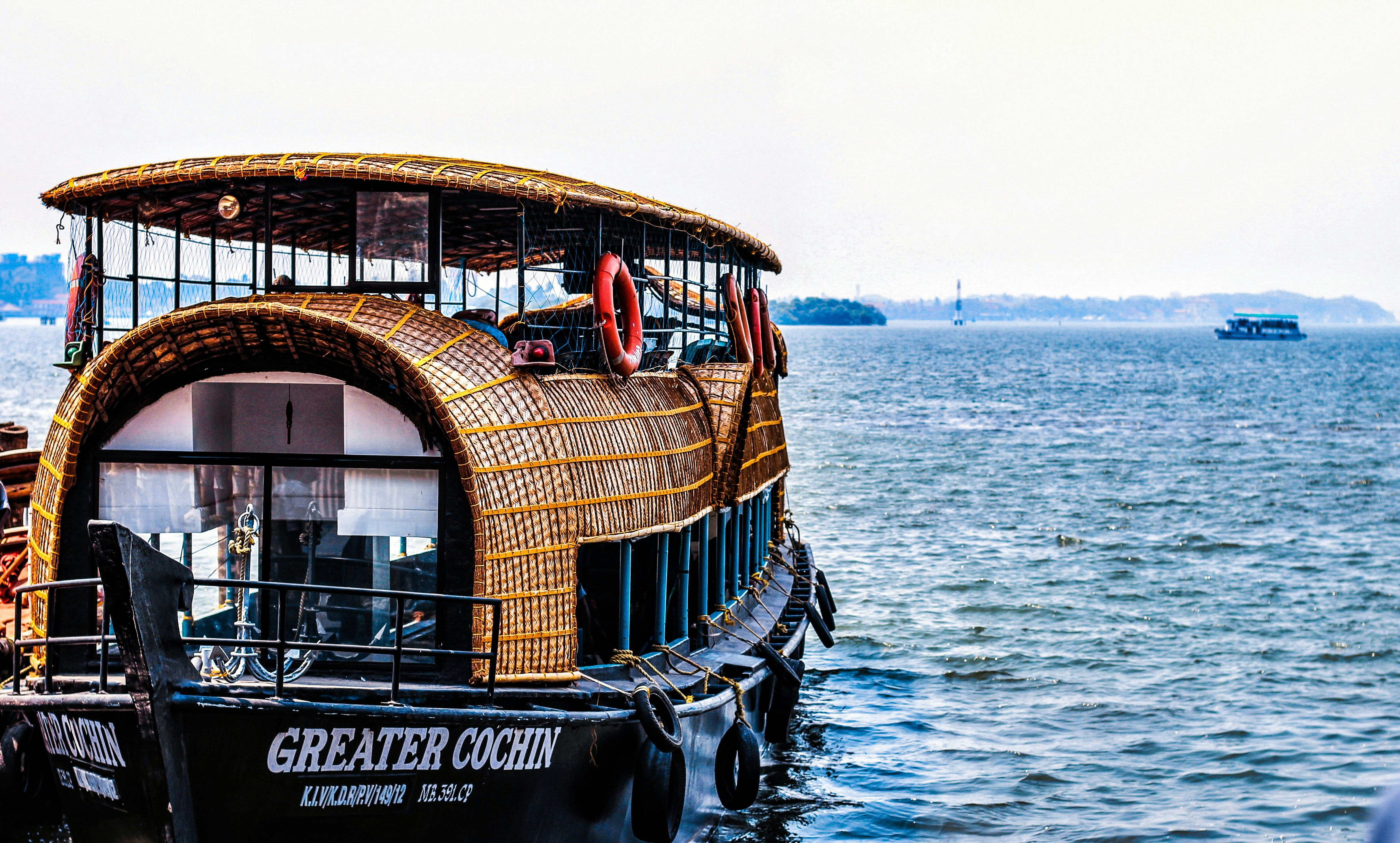 Bamboo-roofed houseboat of Greater Cochin moored along Kerala's tranquil backwaters
