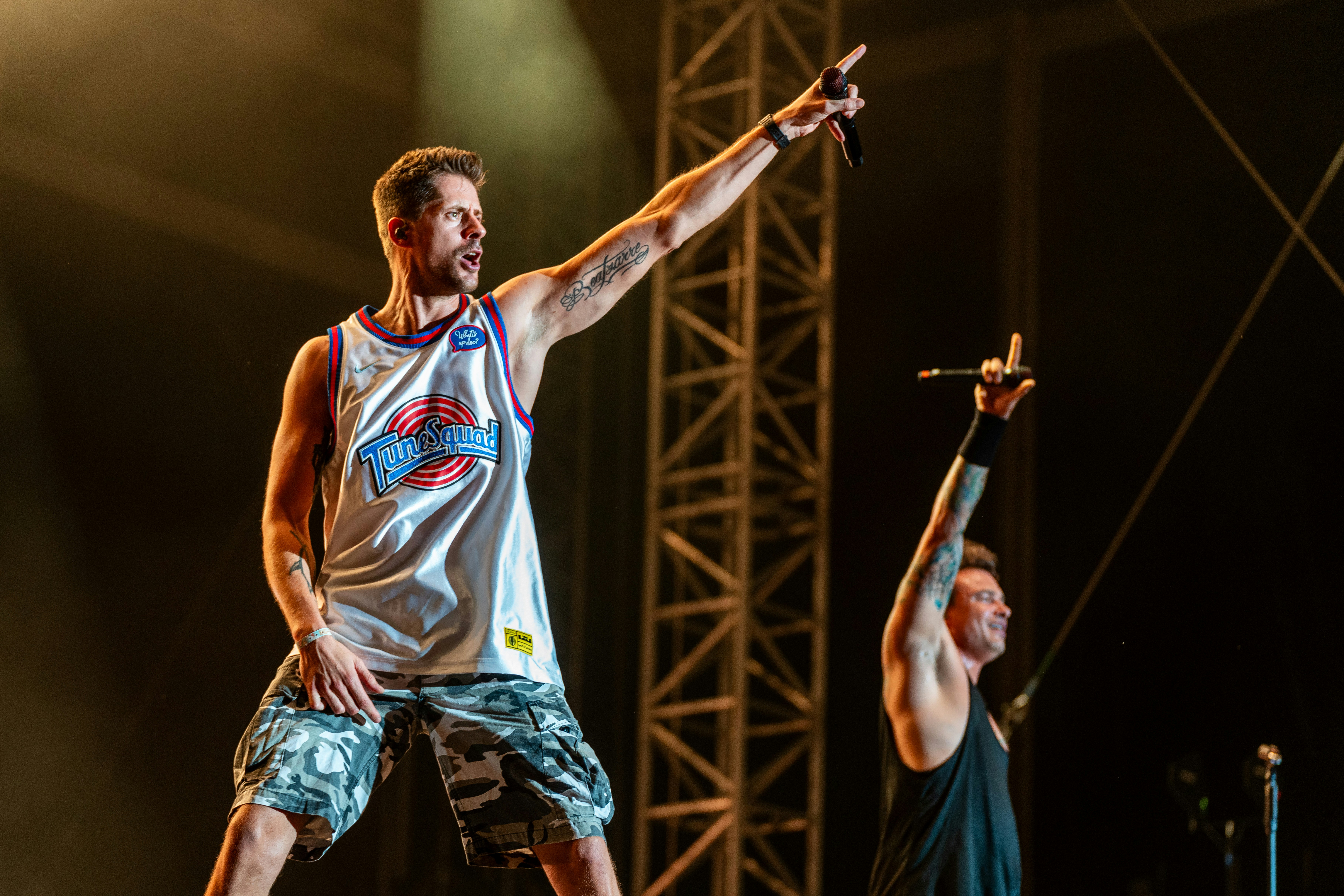 Frontman in Spotlight: A High-Energy Gesture Under Stage Lights