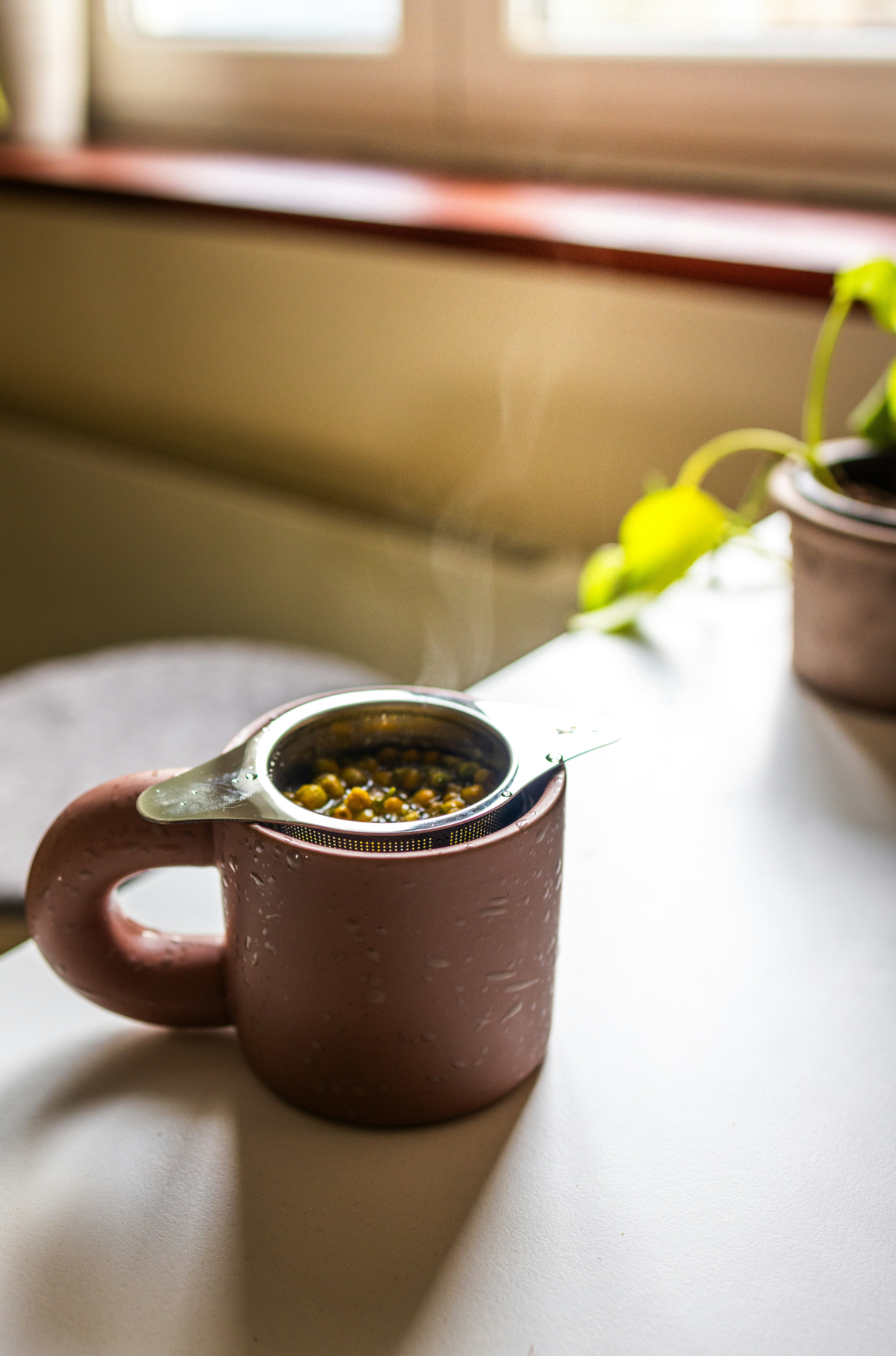 Morning Steam at the Window: A Ceramic Mug with a Metal Infuser