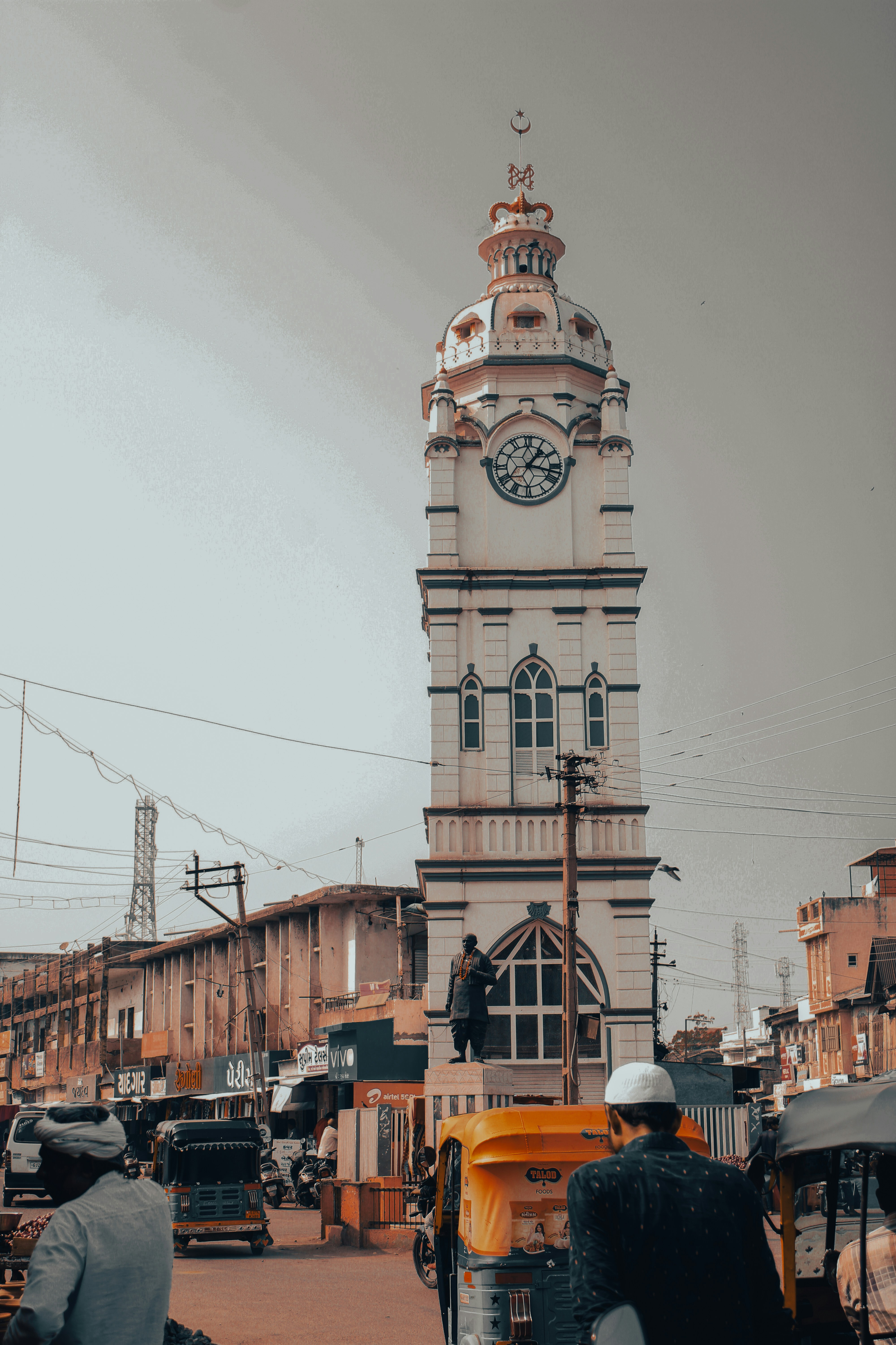 Clock Tower Sentinel Over a Bustling Street Market