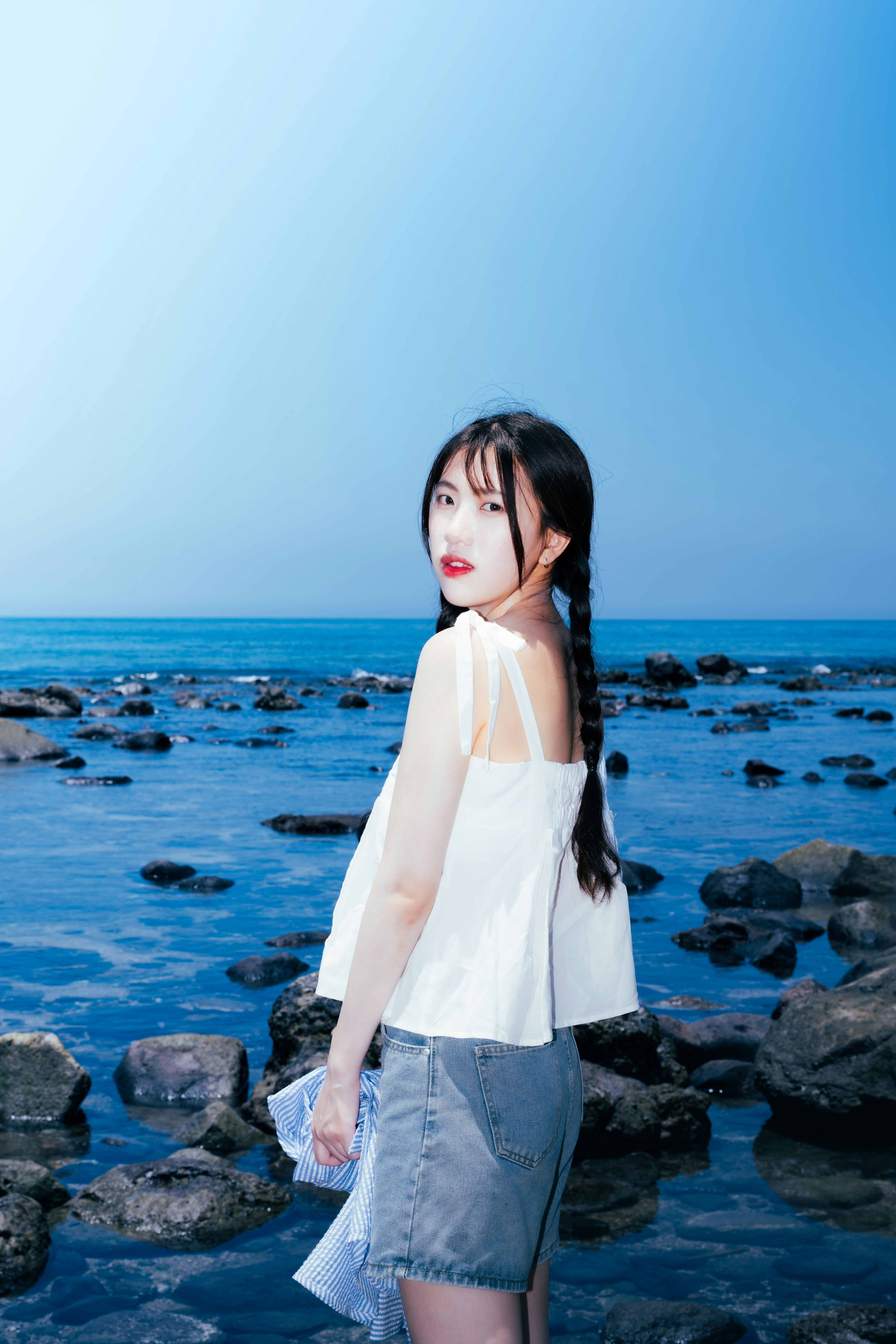 Azure Shoreline Portrait: A Quiet Gaze by the Tide
