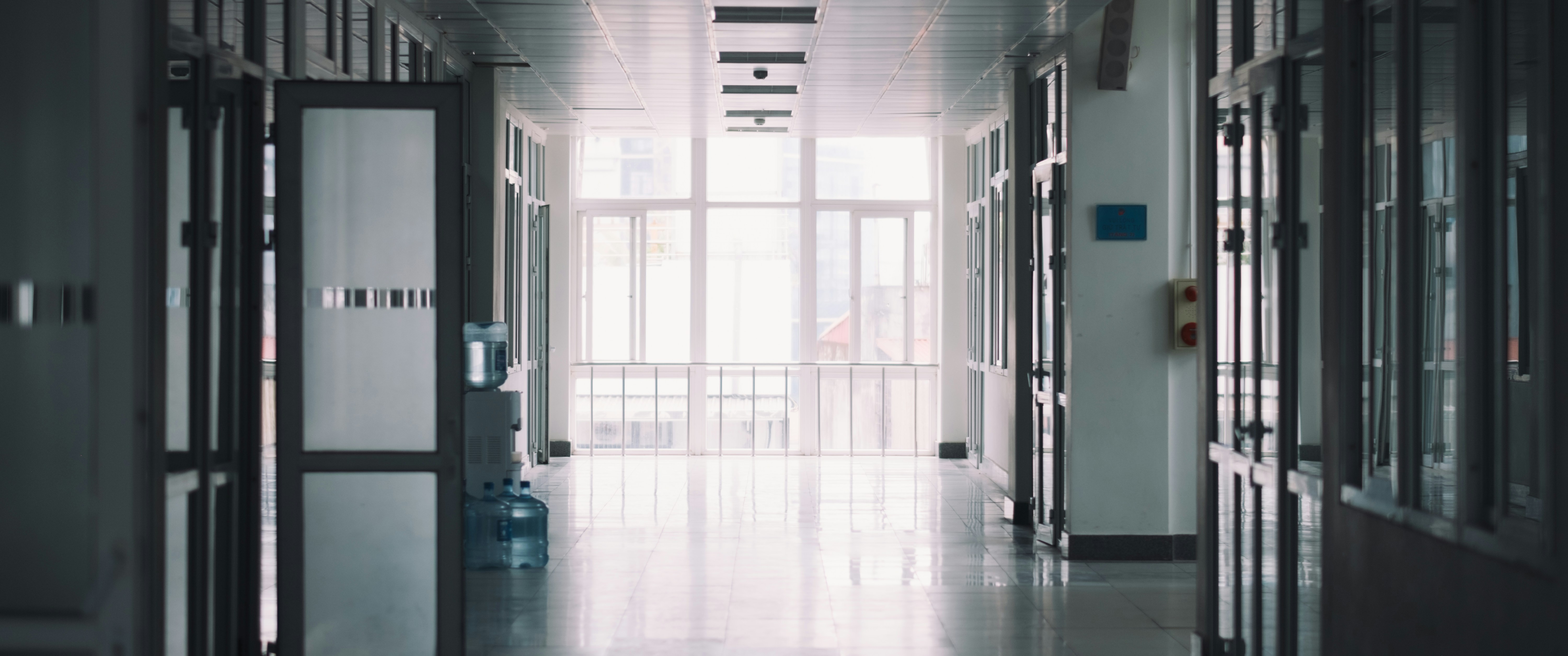 A long hallway leading to a jail cell photo – Free Building Image on ...