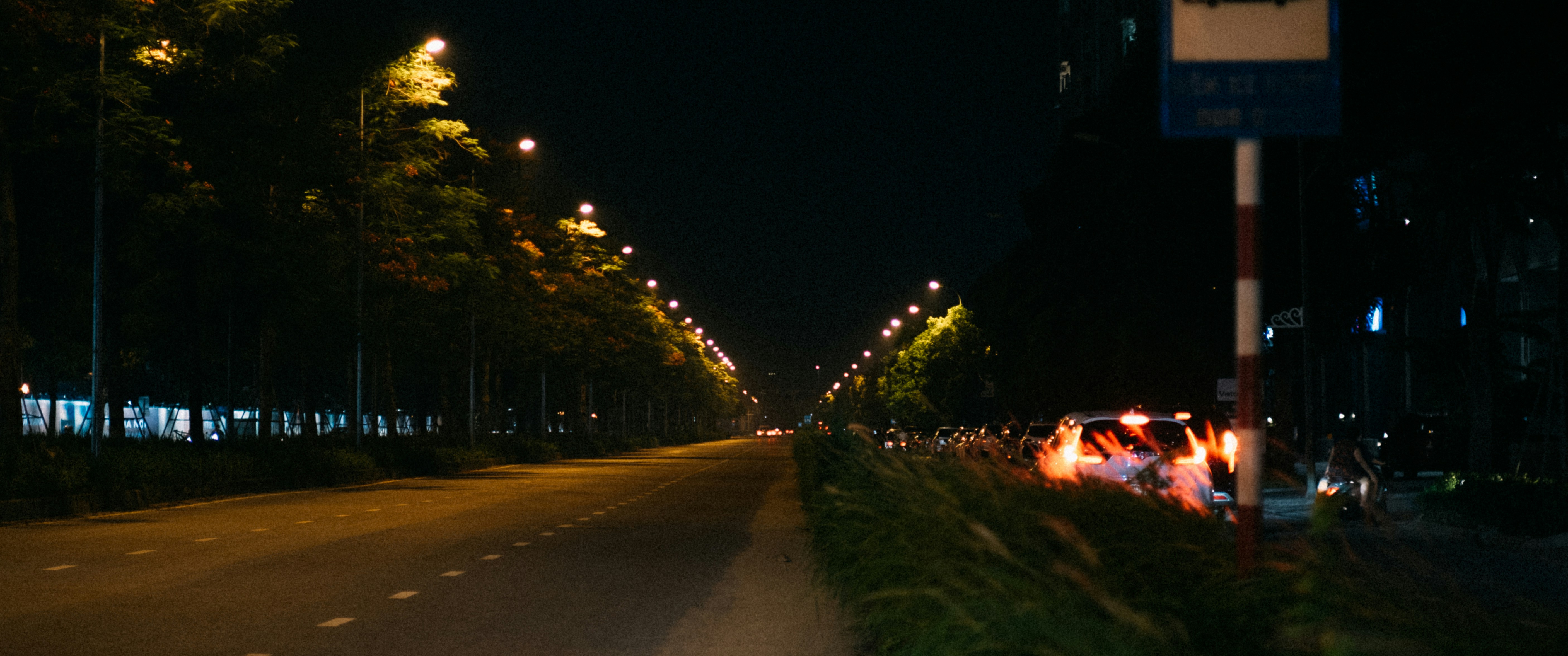 Midnight Corridor: Streetlights Converge Along a Quiet City Avenue
