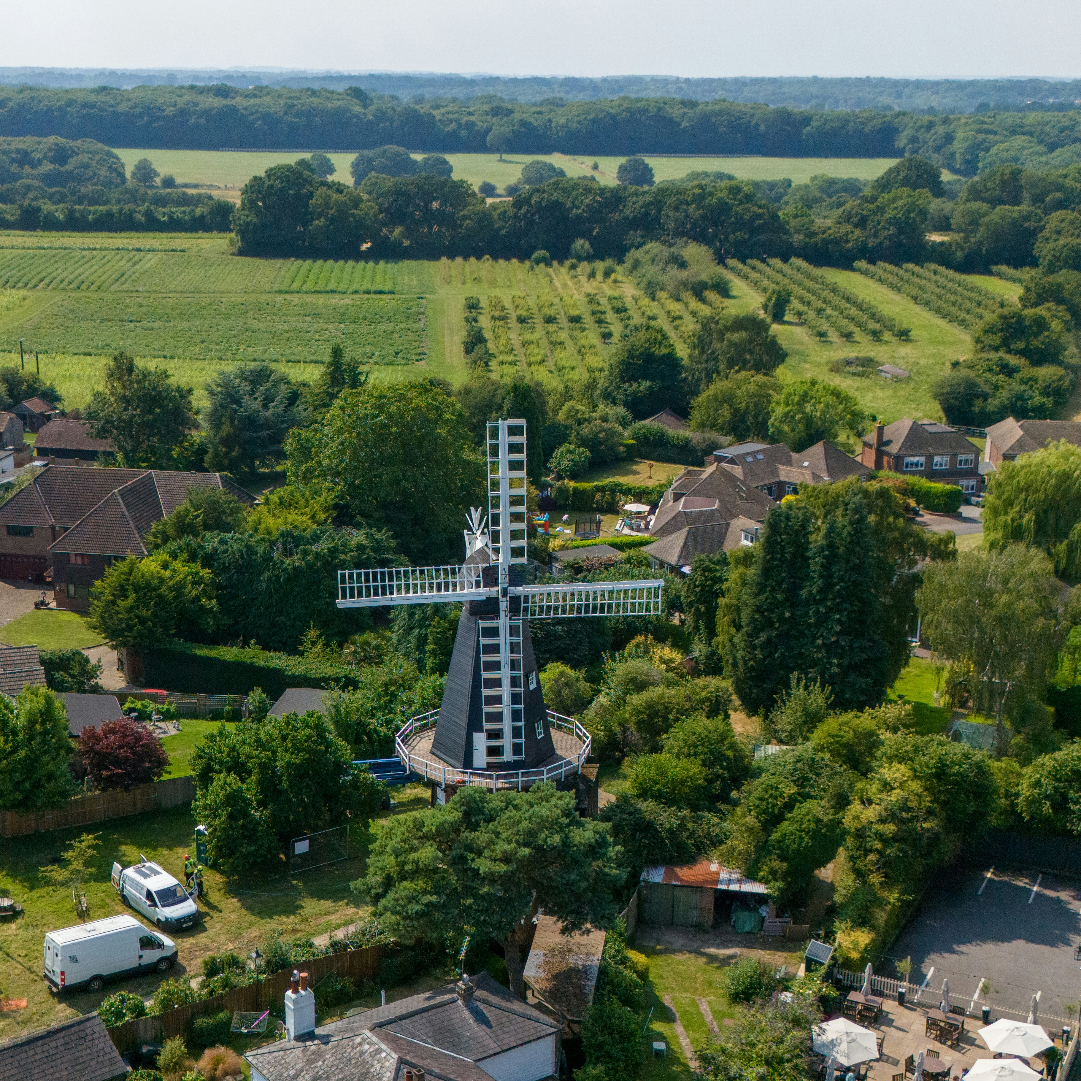 An aerial view of a windmill in the middle of a village photo – Free ...