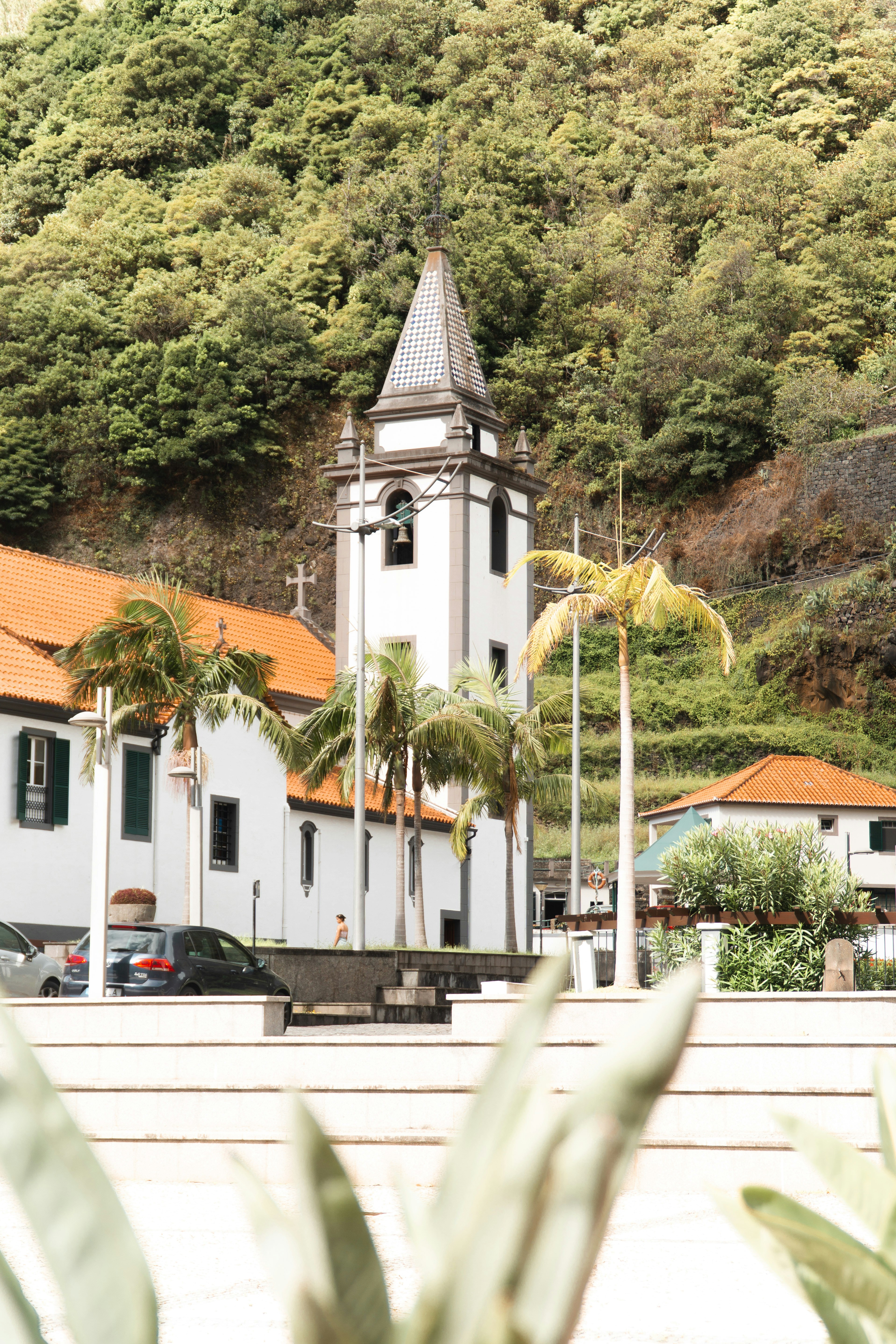 White Chapel Tower Rising Above Tropical Village