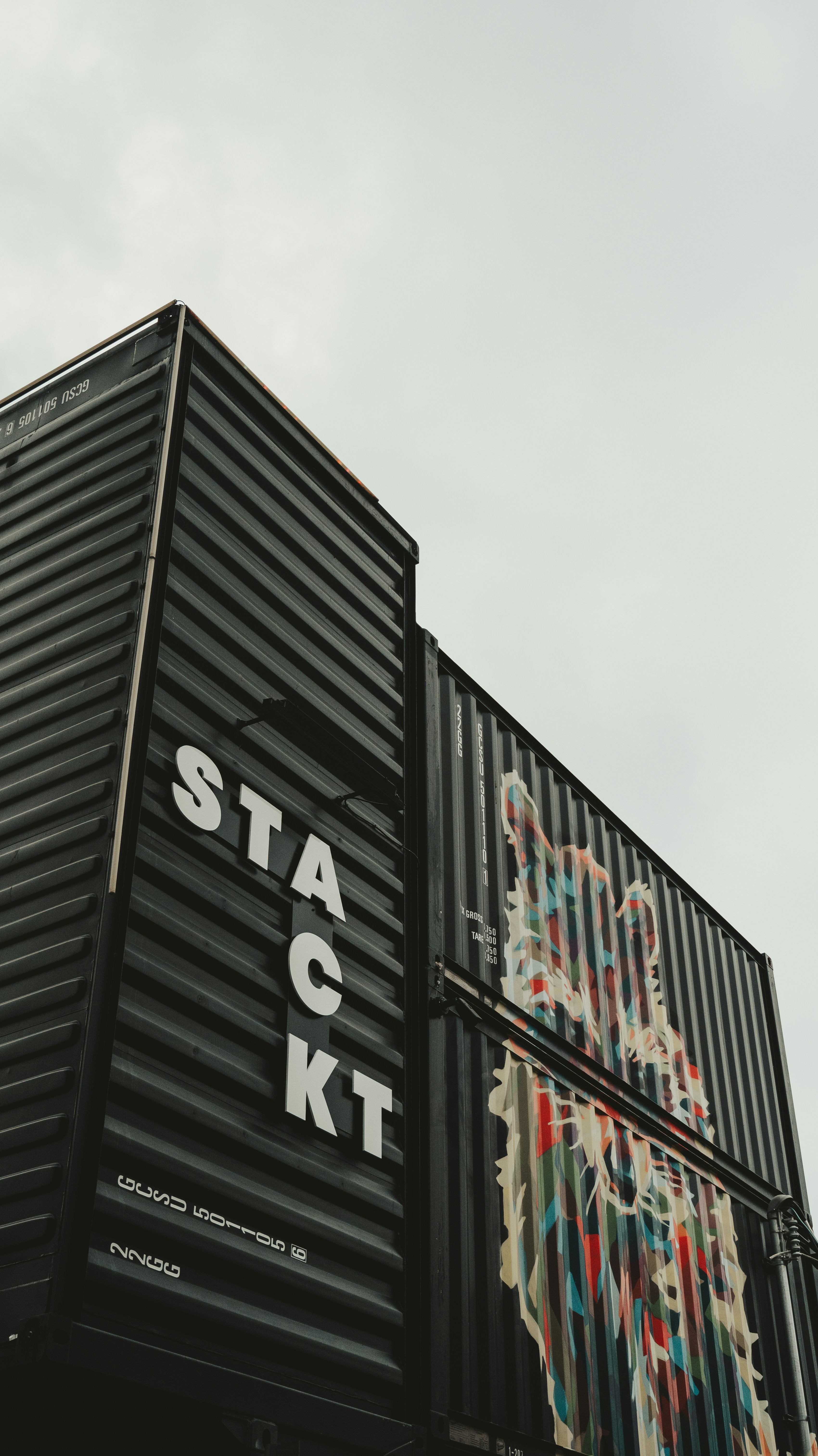 A stack of shipping containers sitting on top of each other photo ...