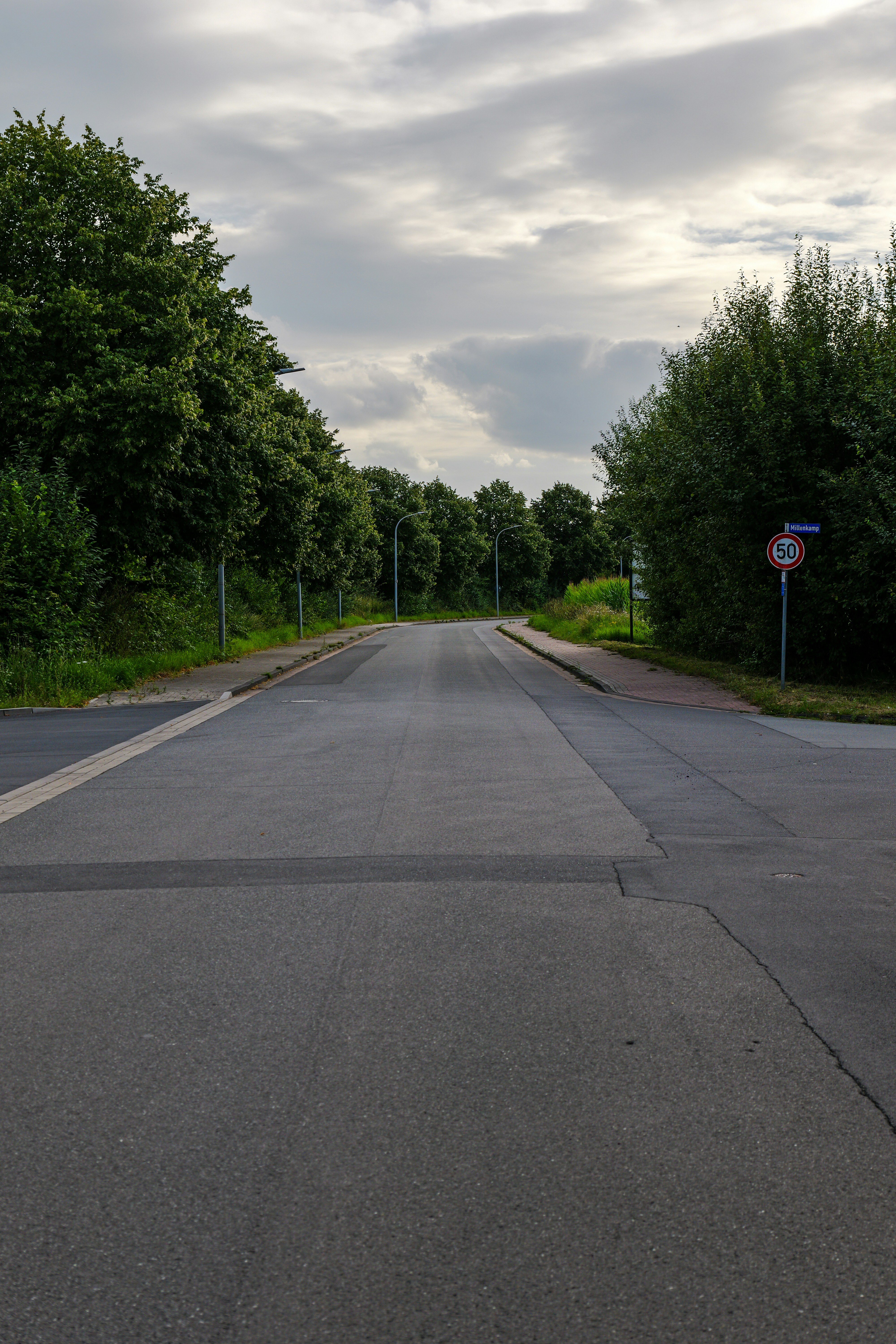 An empty street with a stop sign on the side of it photo – Free City ...