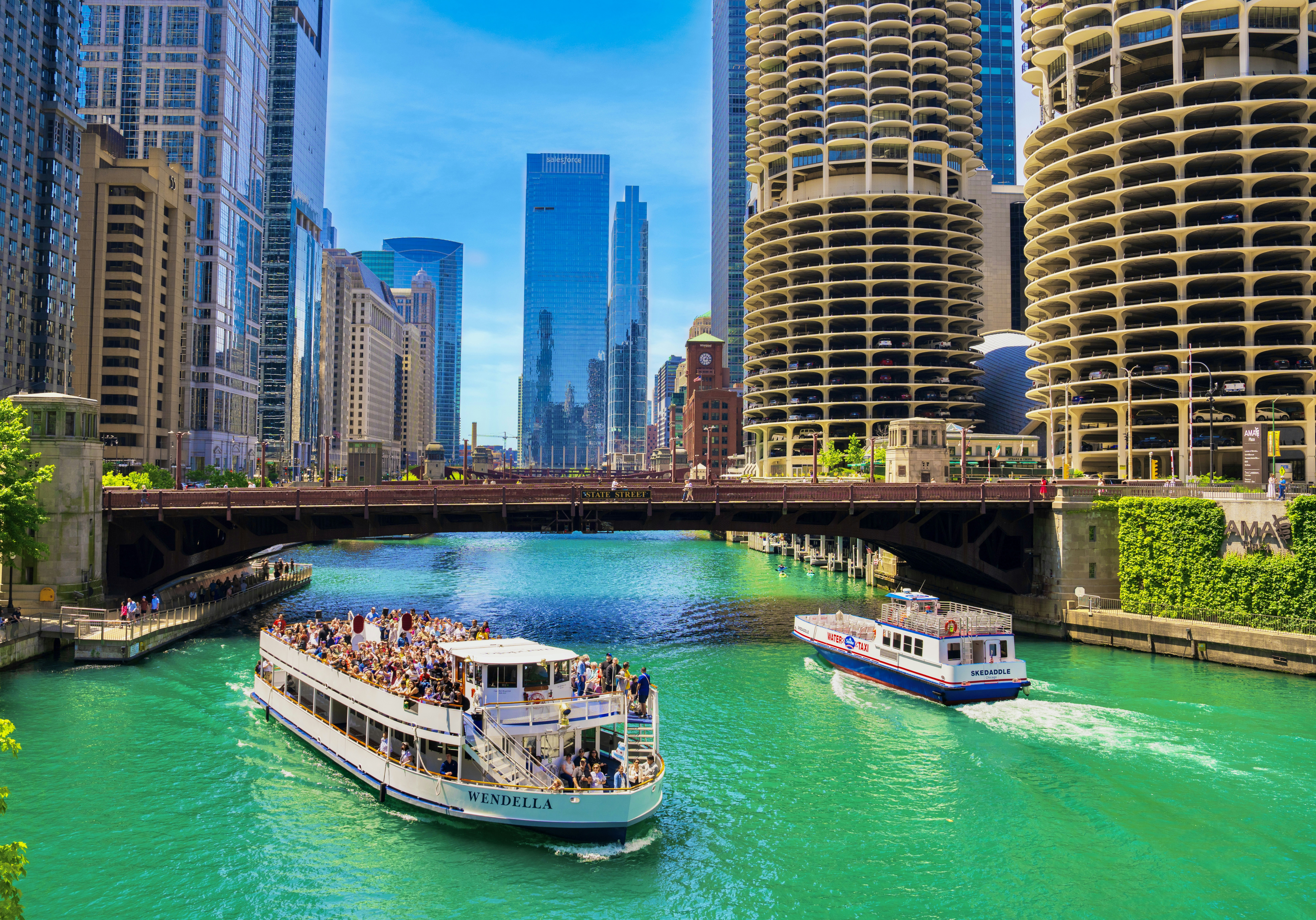 A river filled with lots of green water next to tall buildings photo ...