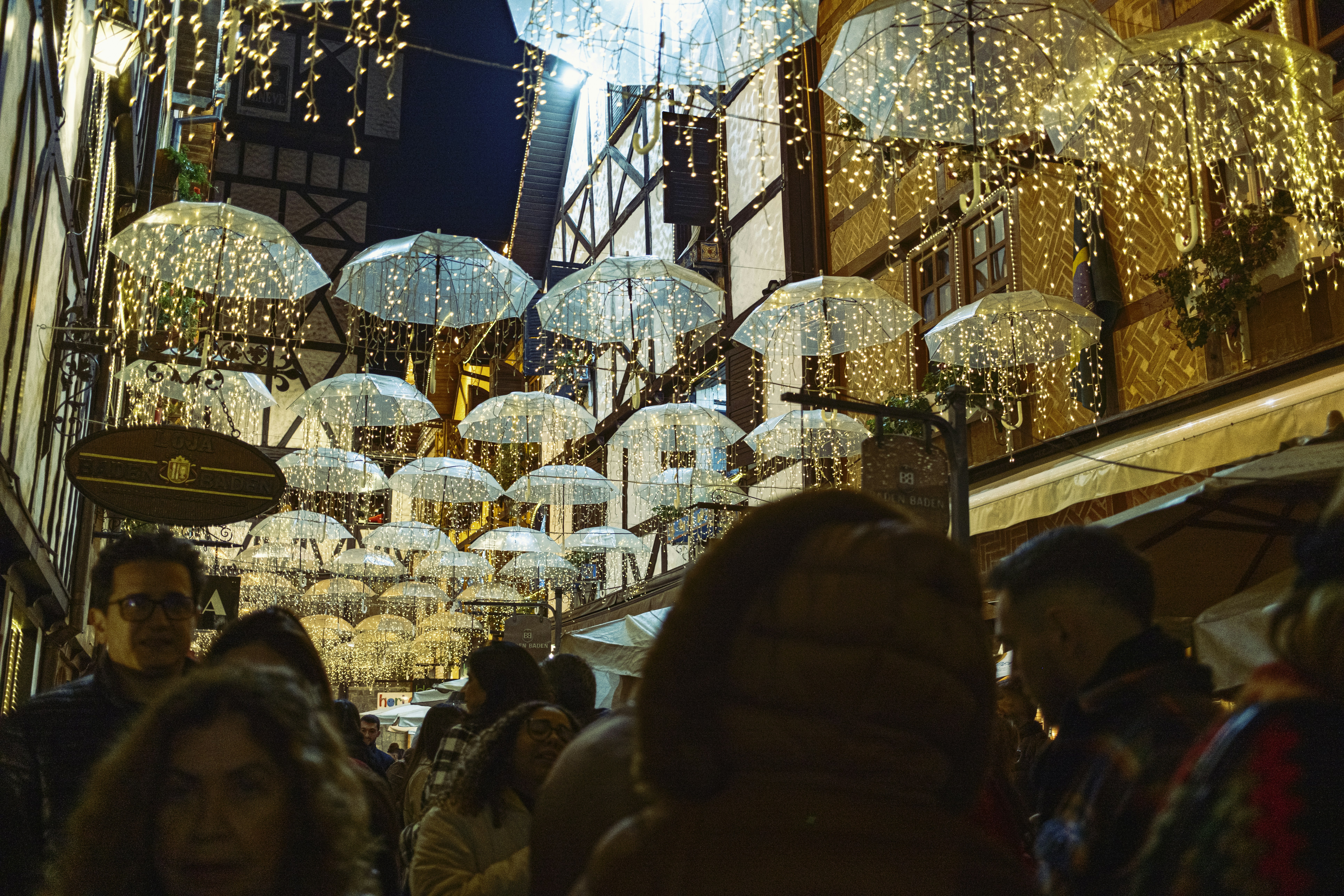 Umbrella Lanterns Over a Murmuring Crowd