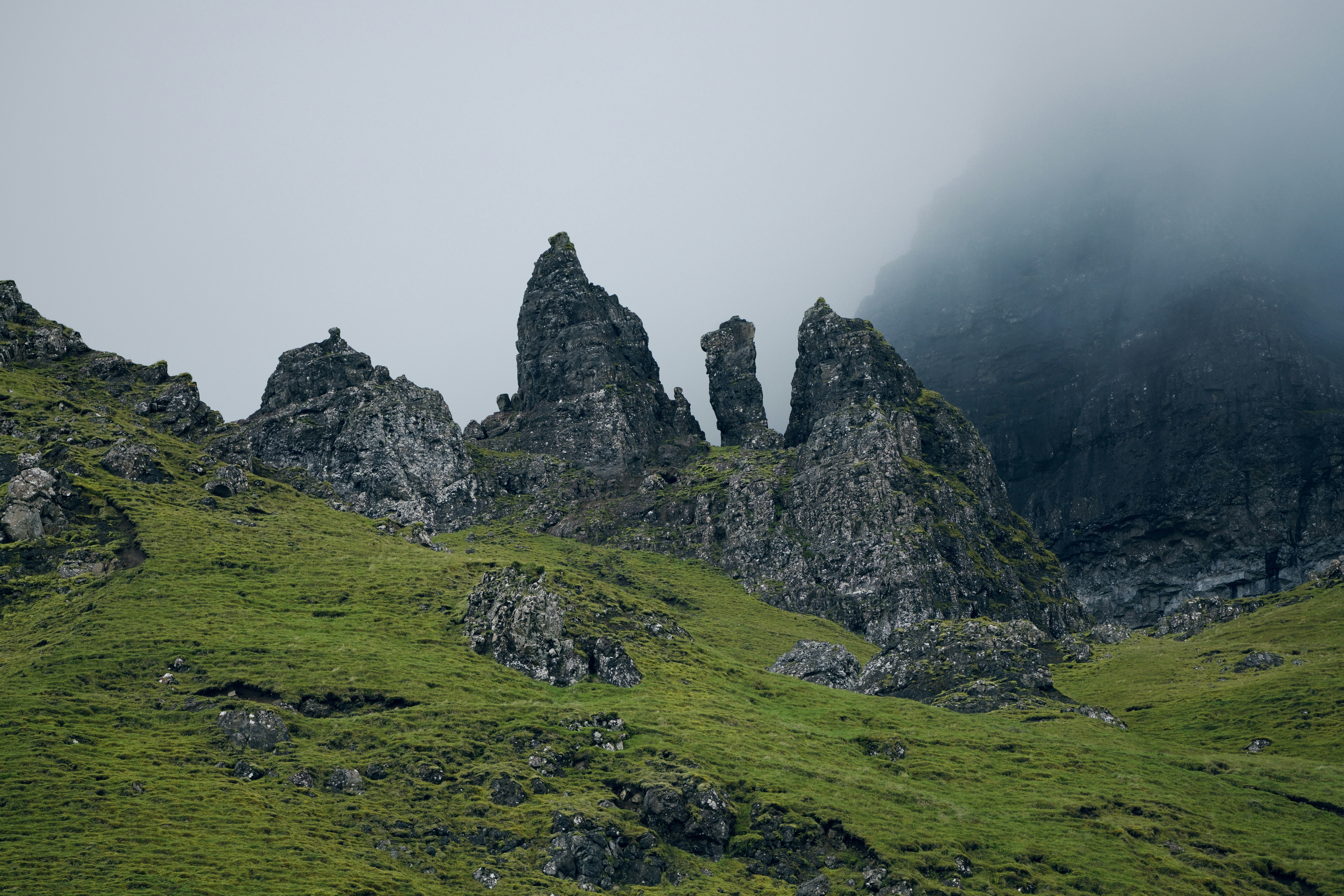 A grassy field with rocks in the background photo – Free Nature Image ...