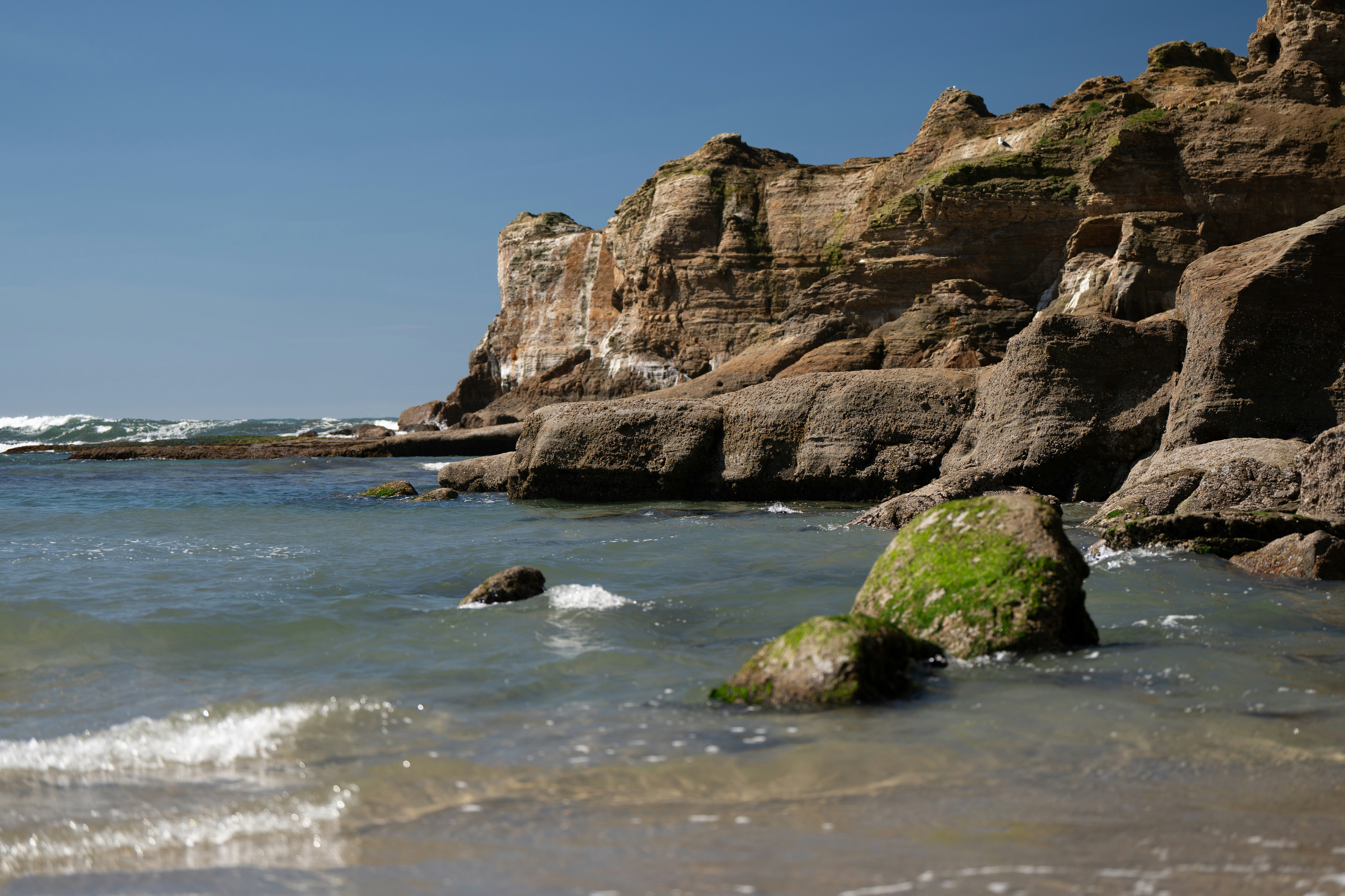 A rocky beach with a body of water