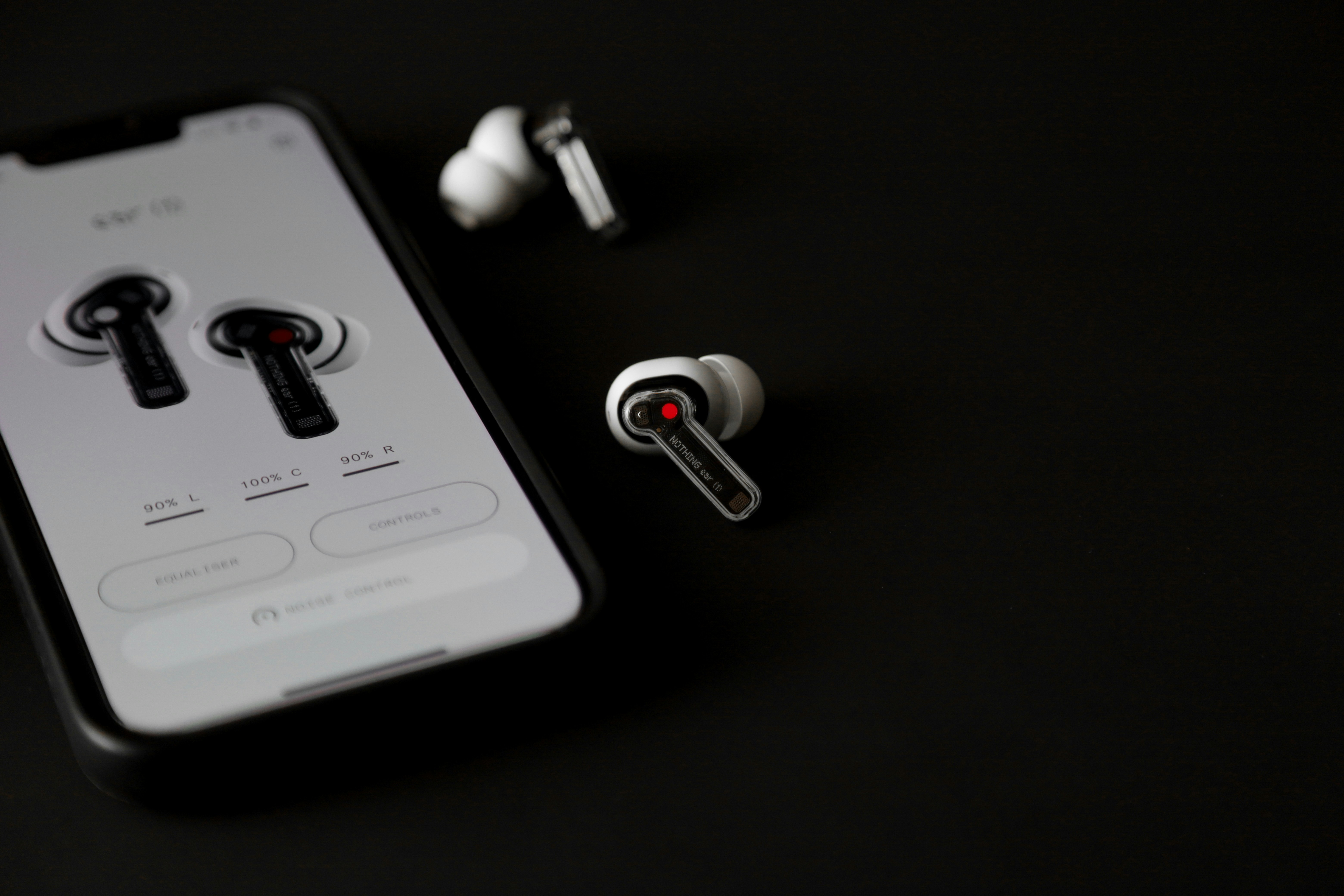 A pair of ear buds sitting next to an iPhone photo – Free Headphones ...