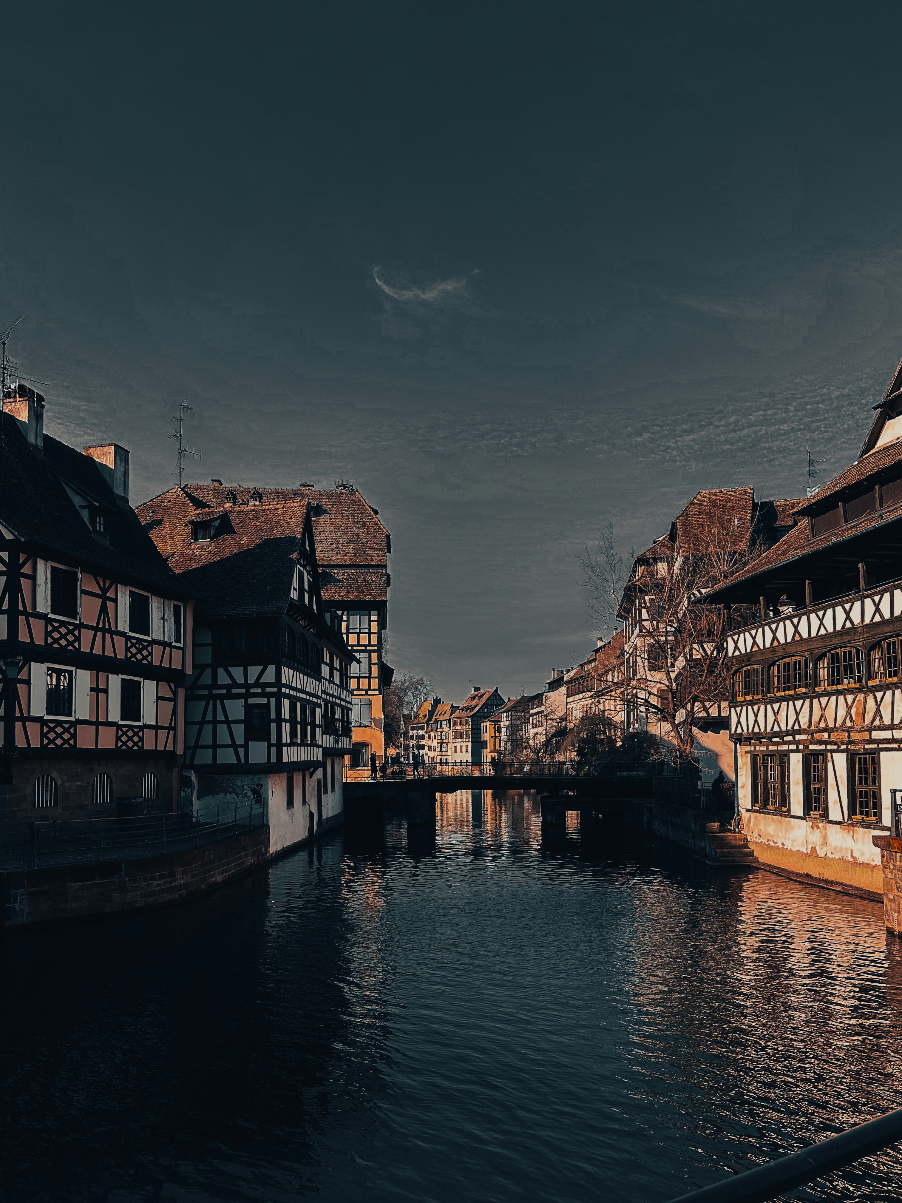 A river running through a city next to tall buildings photo – Free ...