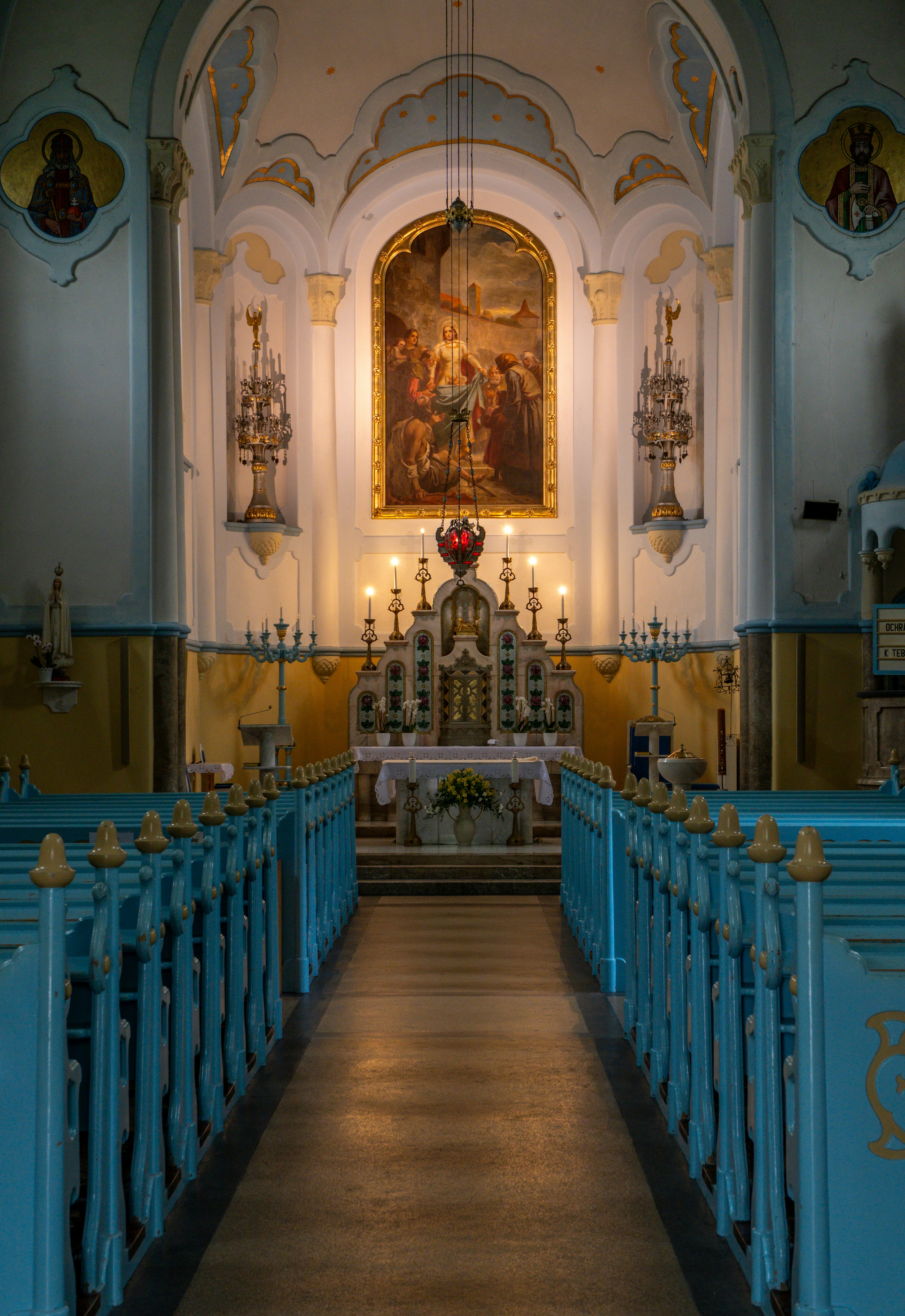 A church with blue pews and a painting on the wall photo – Free ...