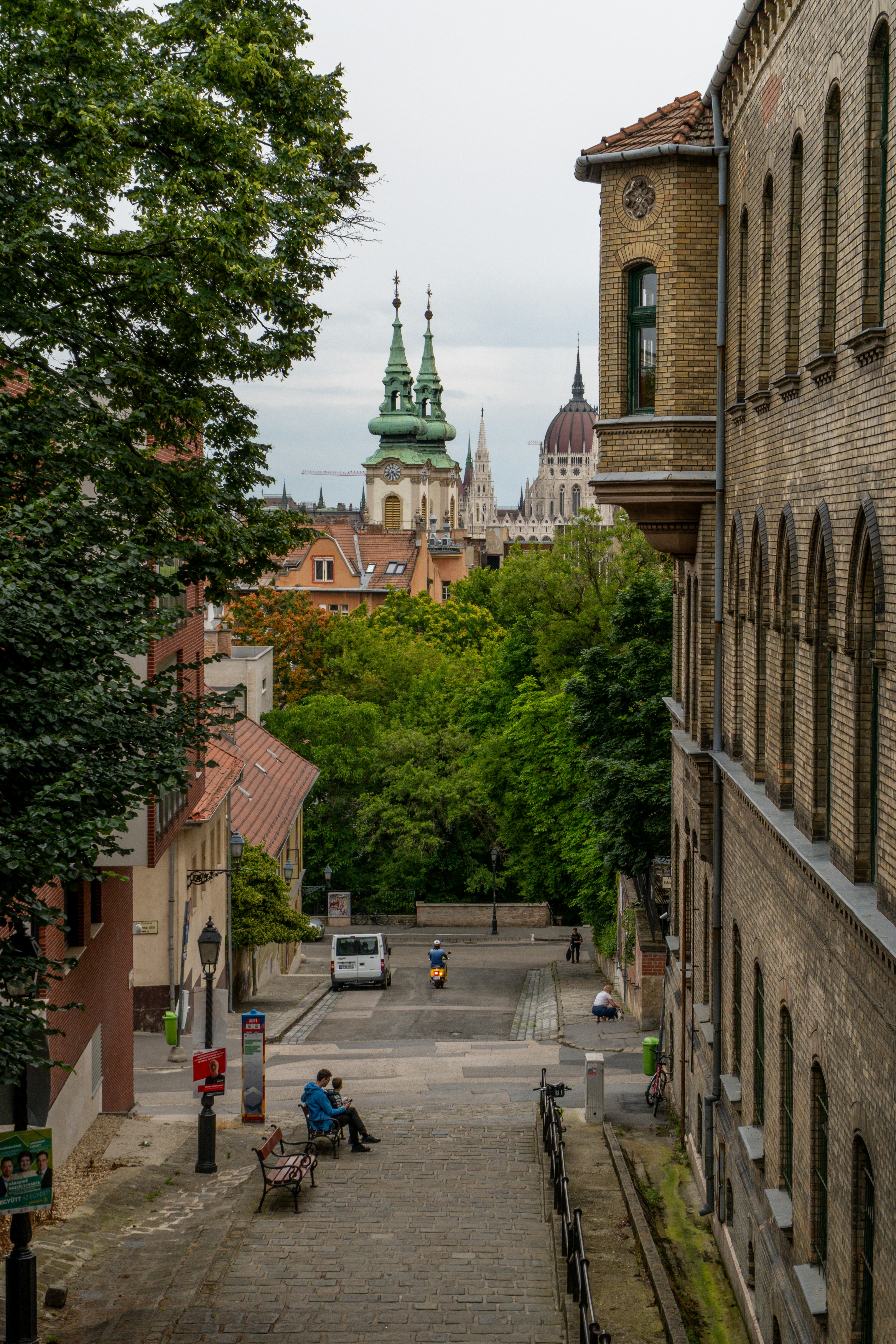 Cobblestone Path Toward Emerald Domes and City Spires