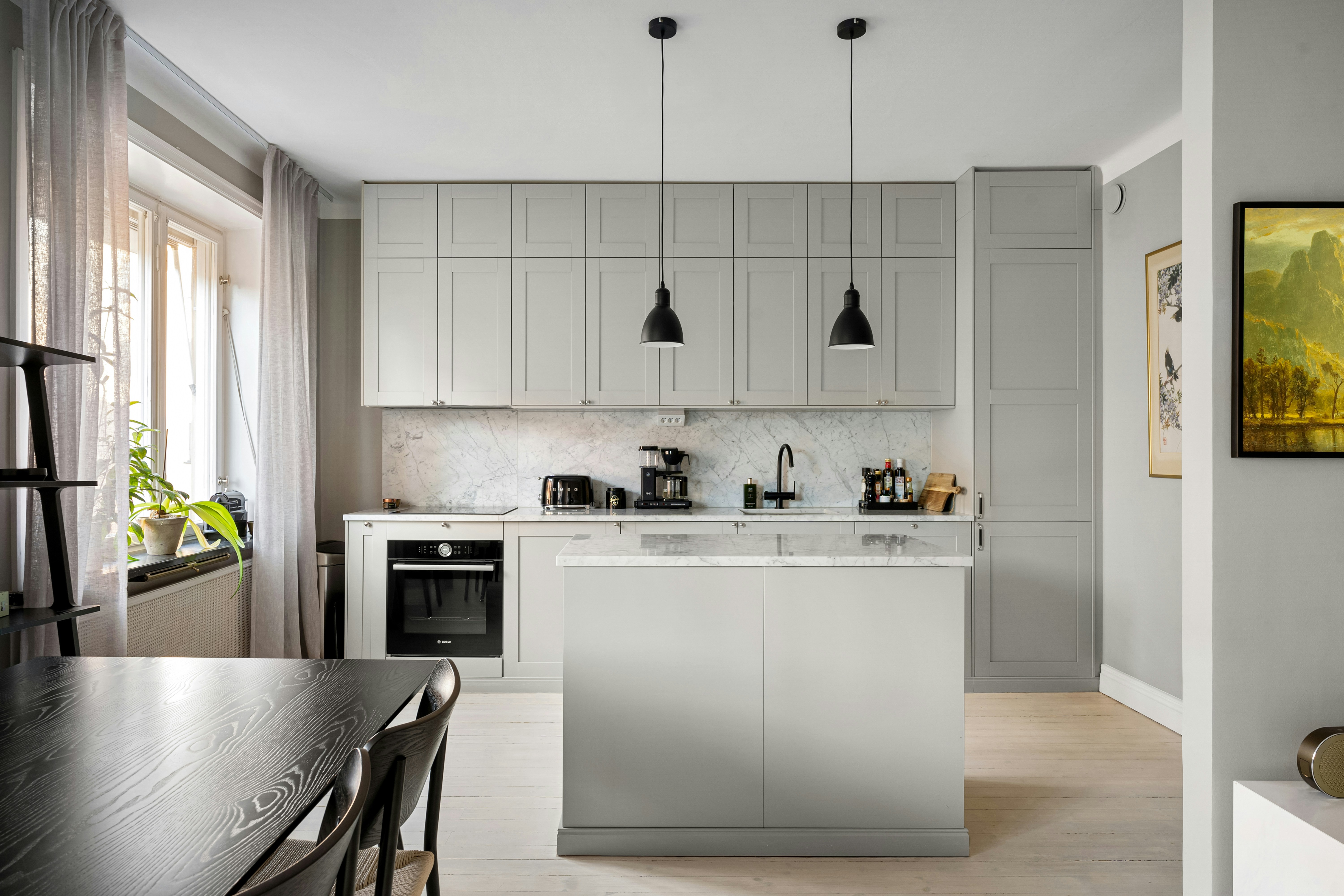 A kitchen with a table and chairs in it photo – Free Interior design ...