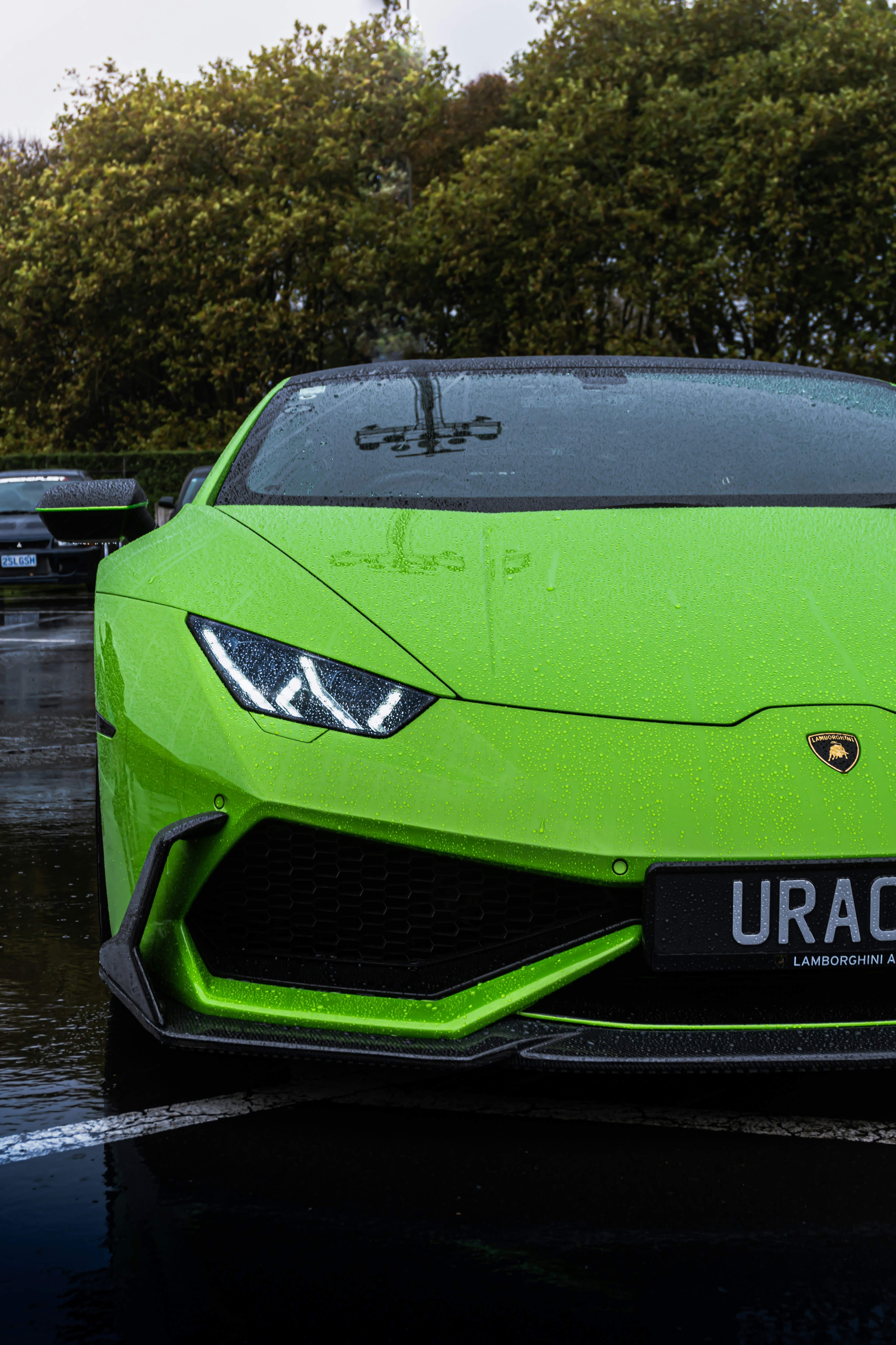 Emerald Force: Front-Quarter of a Lamborghini Huracán in a Wet Parking Lot