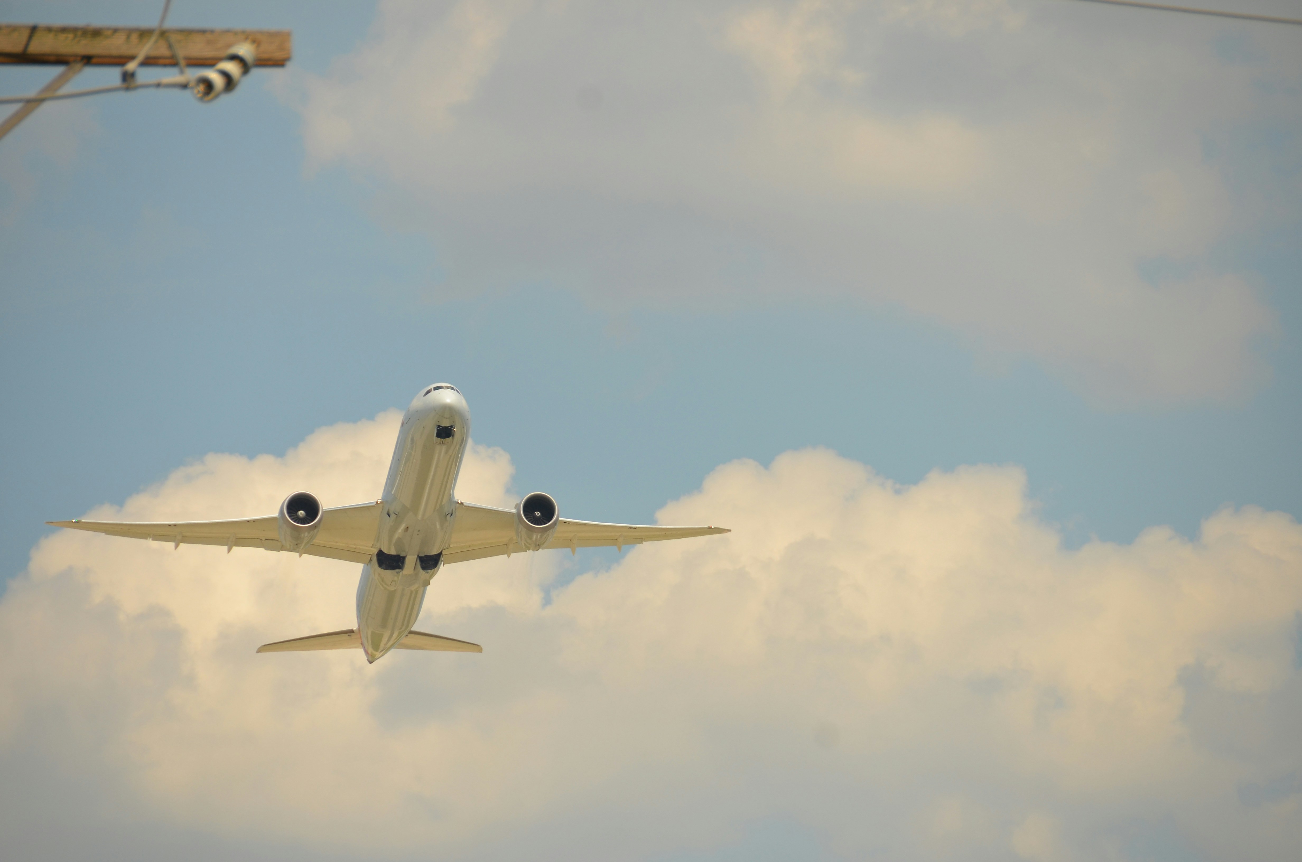 Jet in Profile: Climbing Through Puffy Clouds