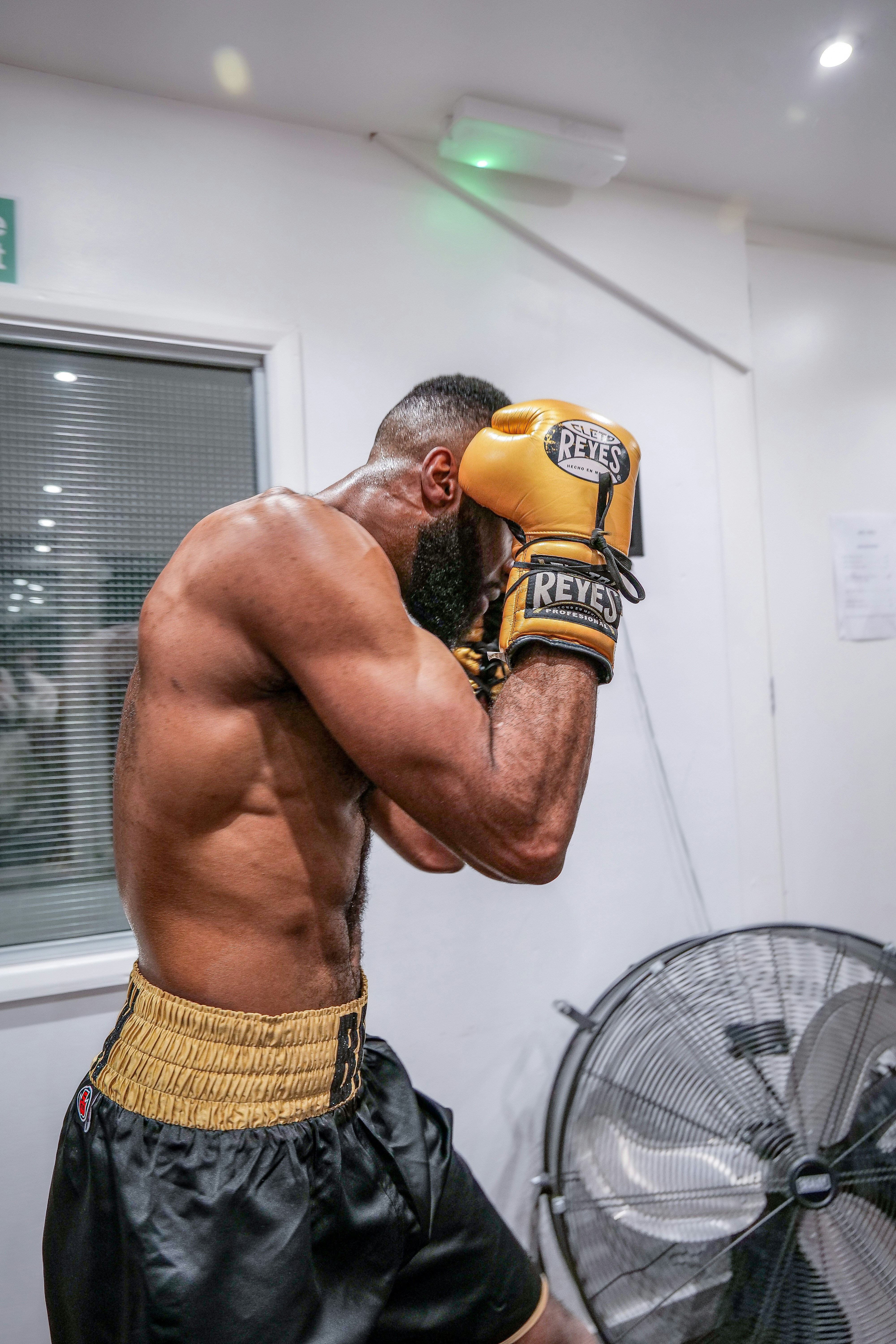 A man with a yellow boxing glove on his head photo – Free Man Image on ...