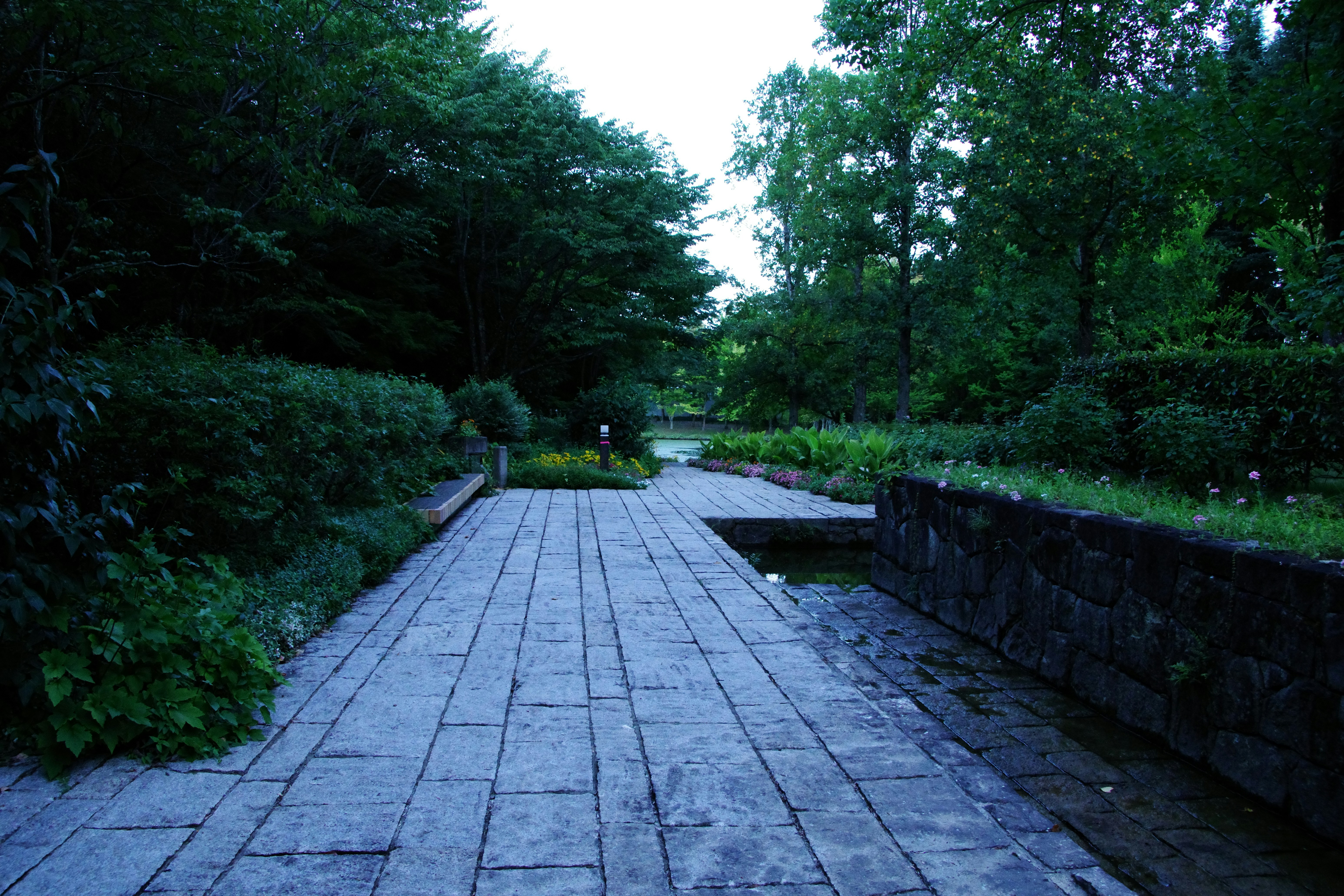 Blue Hour Concourse: A Quiet Stone Path Toward a Distant Figure