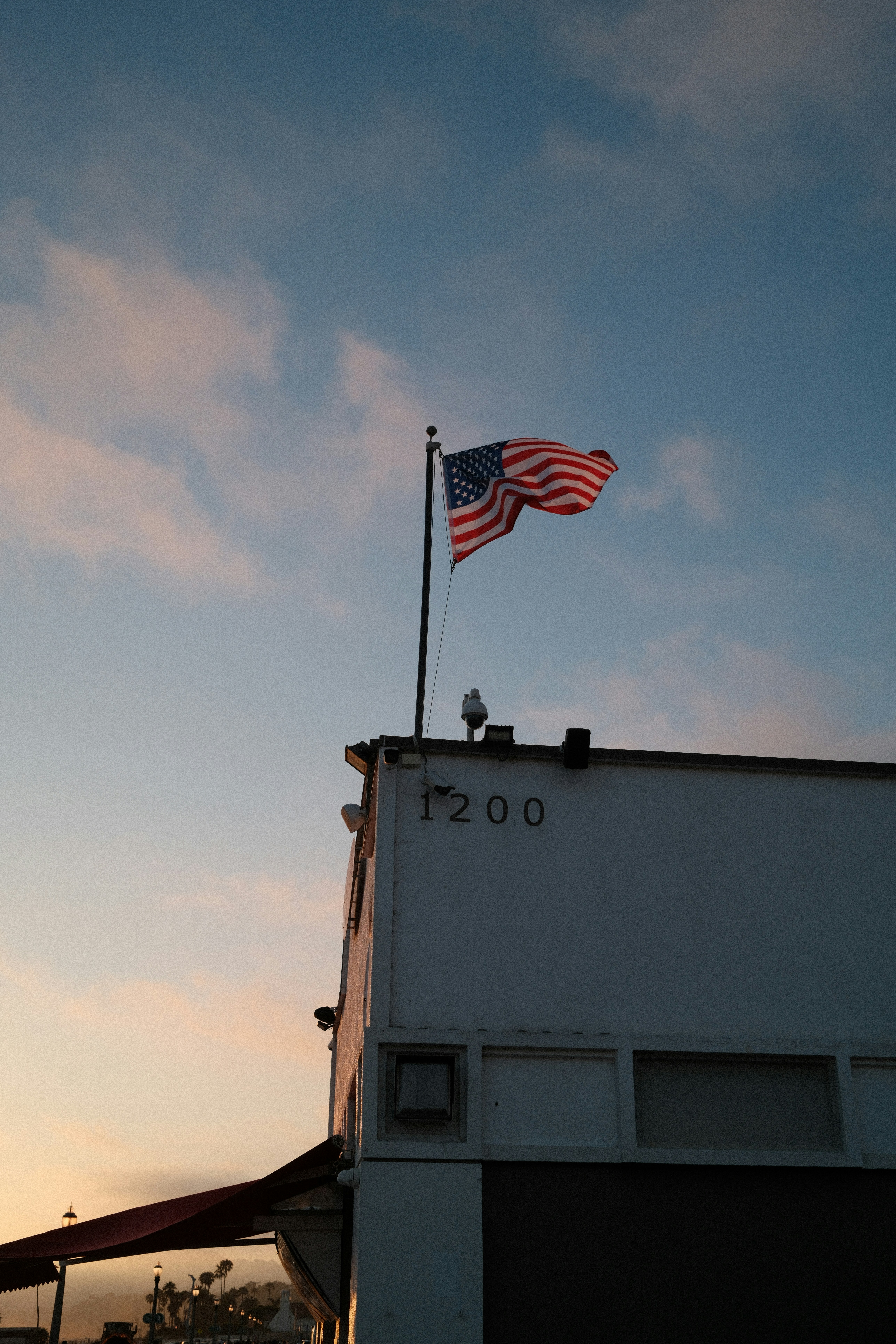 Flag on the Crest: Dusk over a Quiet Municipal Facade