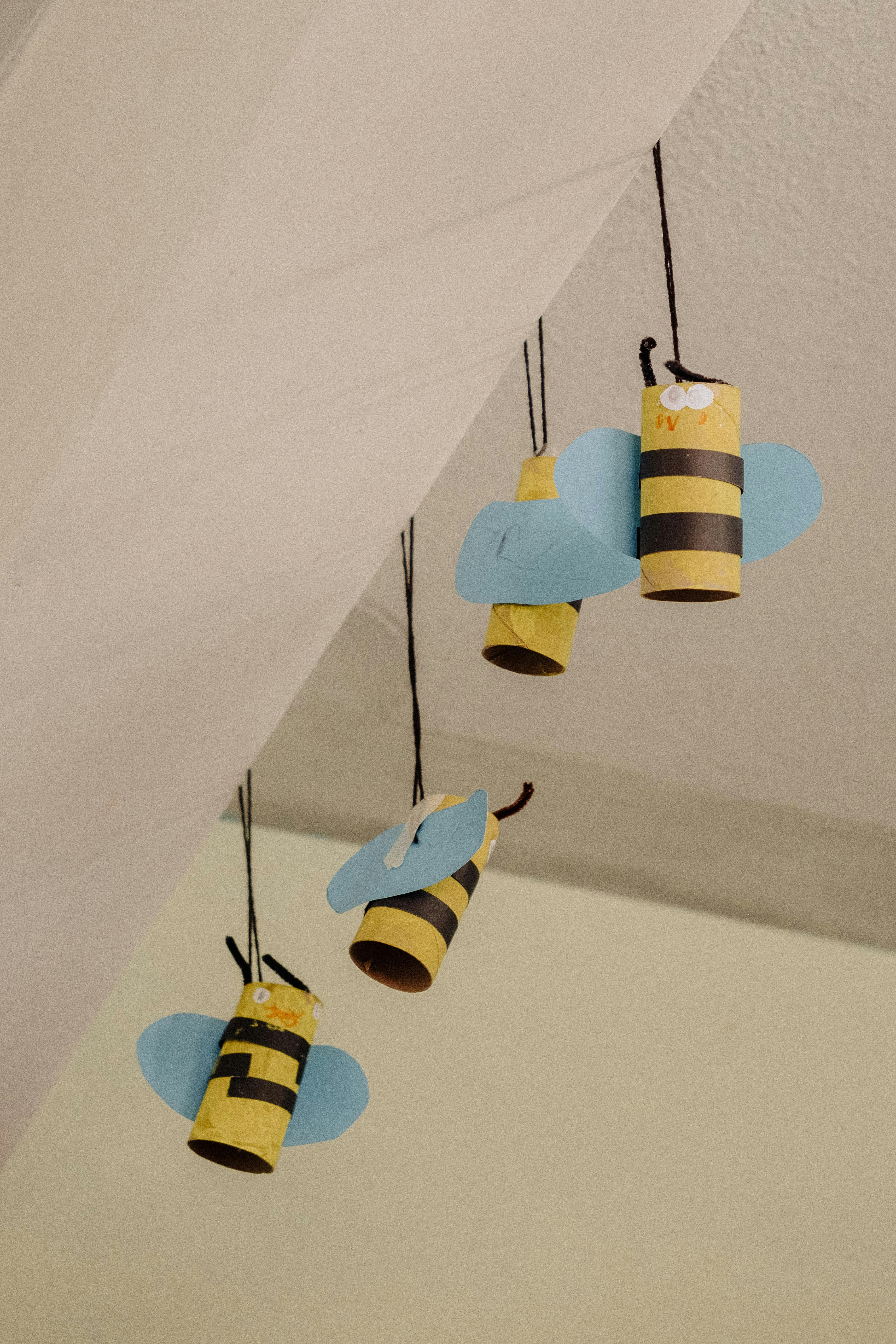 A group of bees hanging from a ceiling