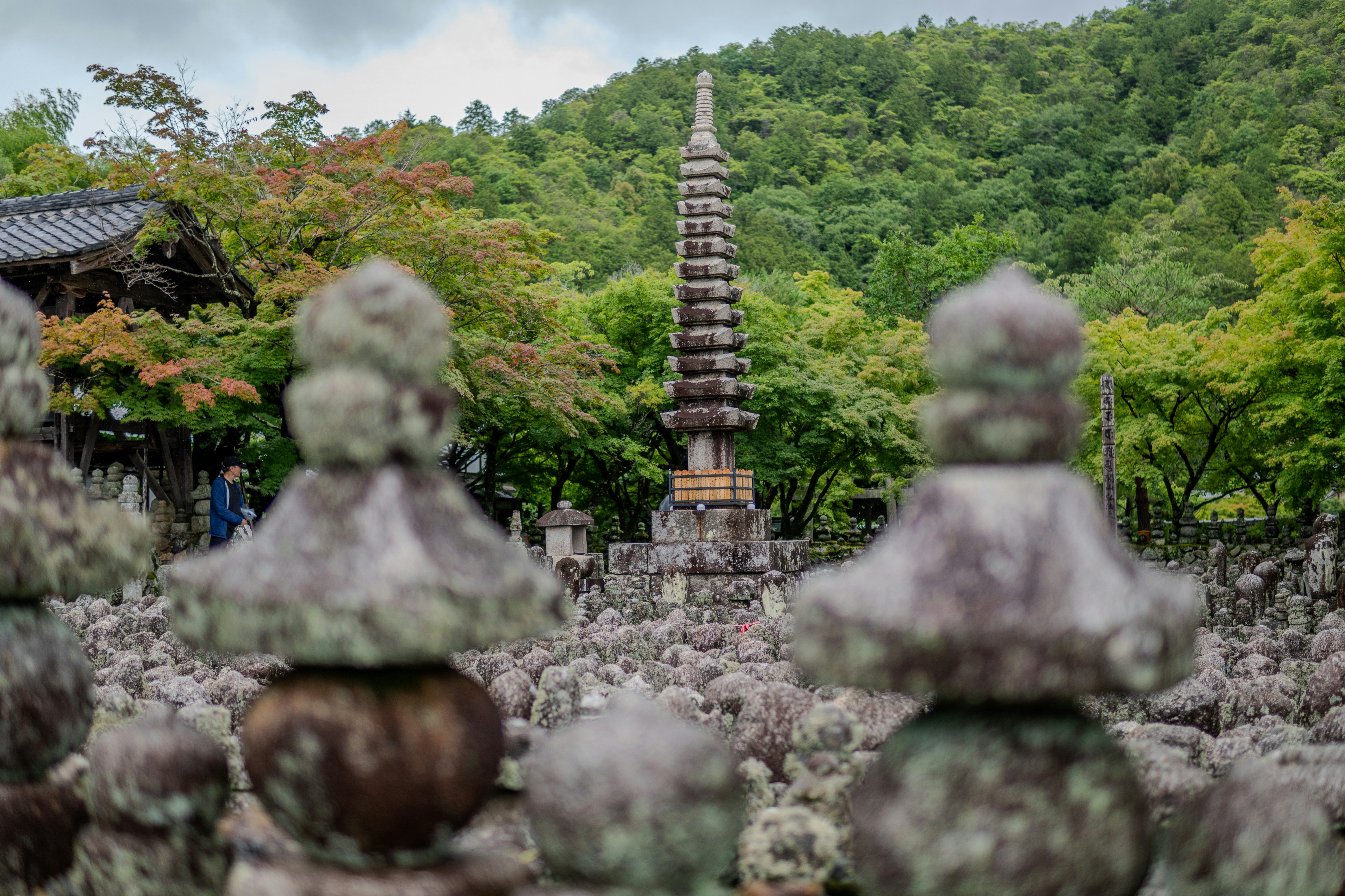 Stone Guardians Framing a Centered Pagoda amid Mossy Terraces