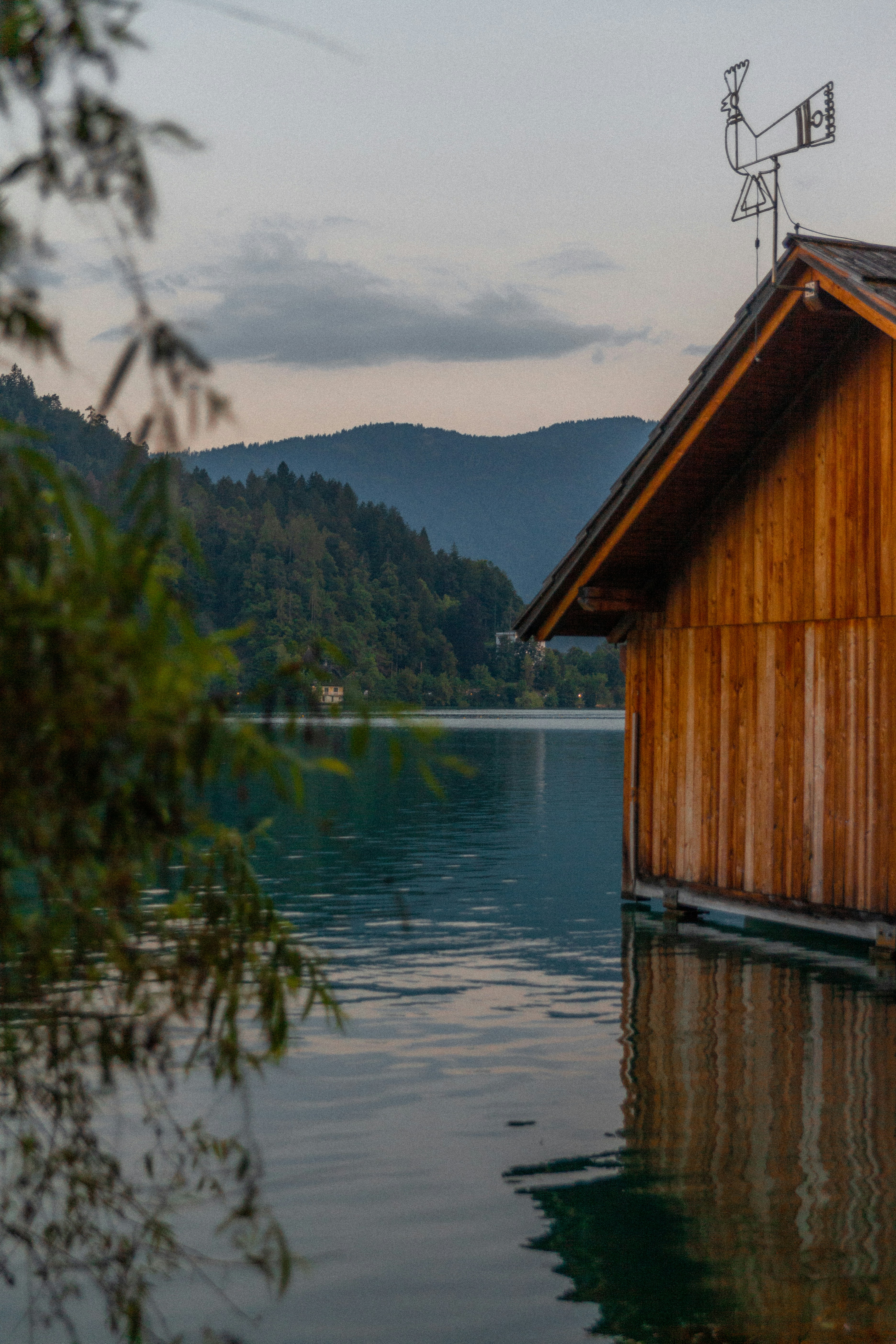 Lakeside Boathouse at Dusk with Weather Vane Silhouette