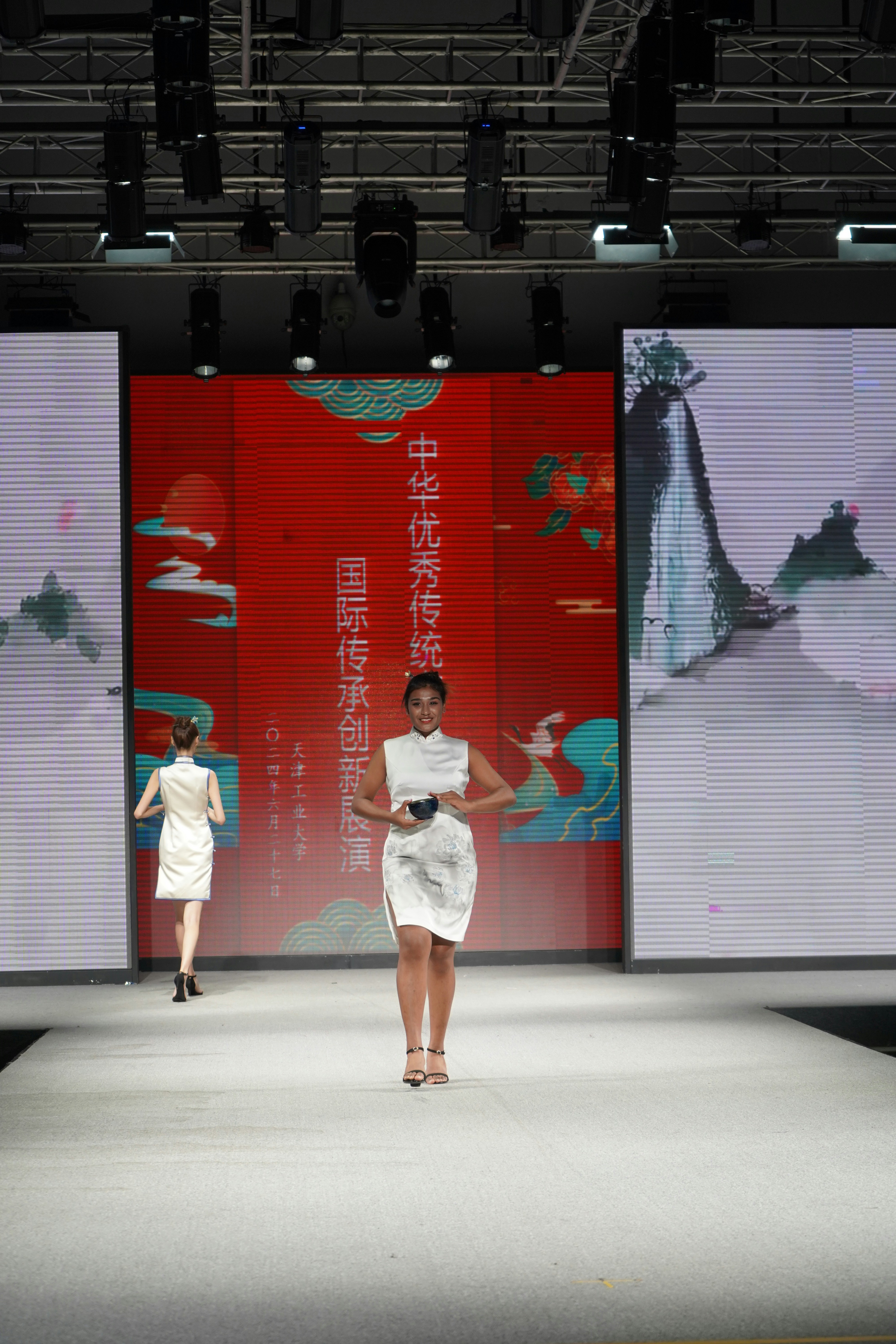 White Silk on a Crimson Runway: Center Stage Amid Chinese-Inspired Backdrops
