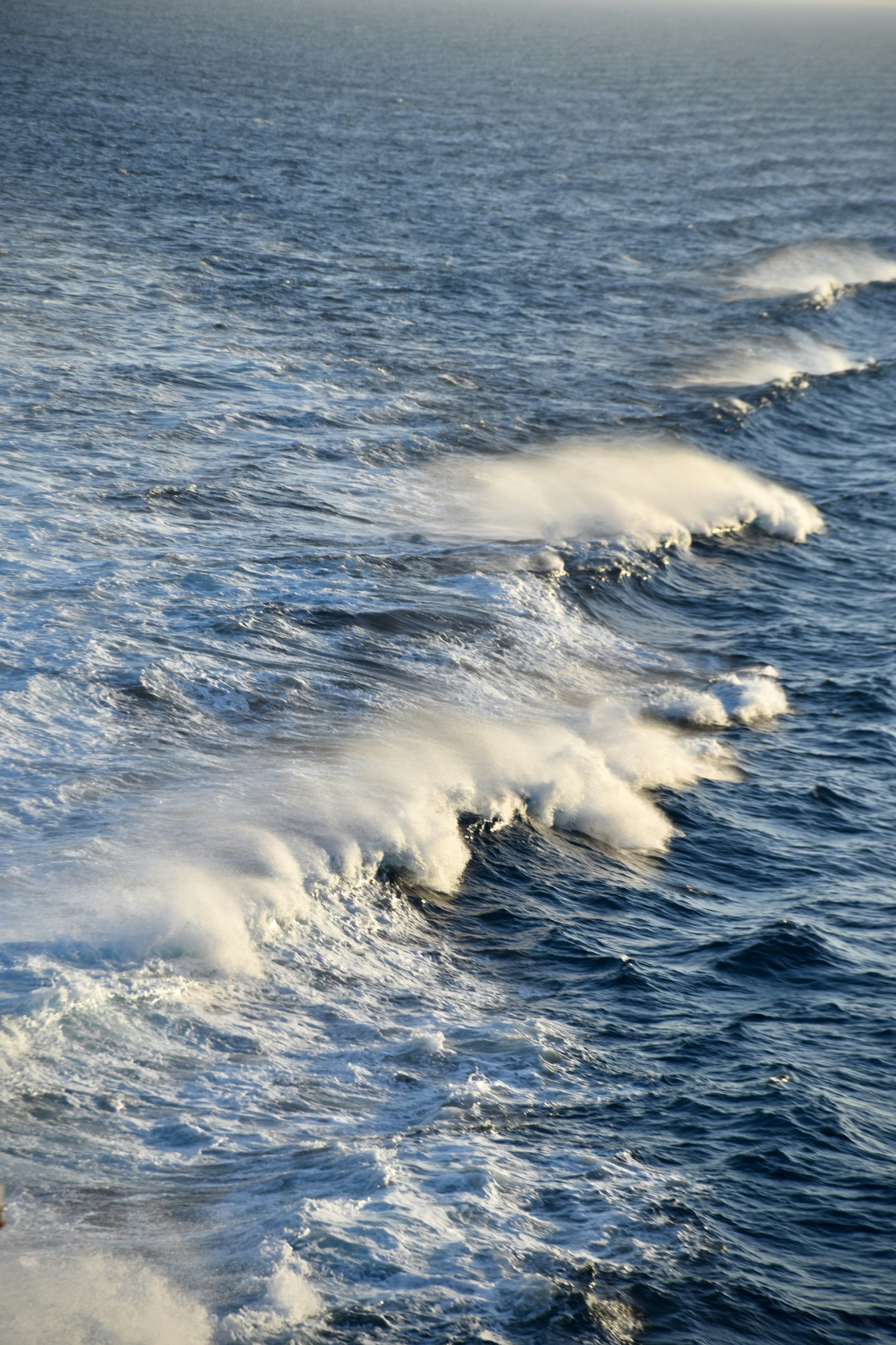 A boat traveling on the ocean with a lot of water behind it photo ...