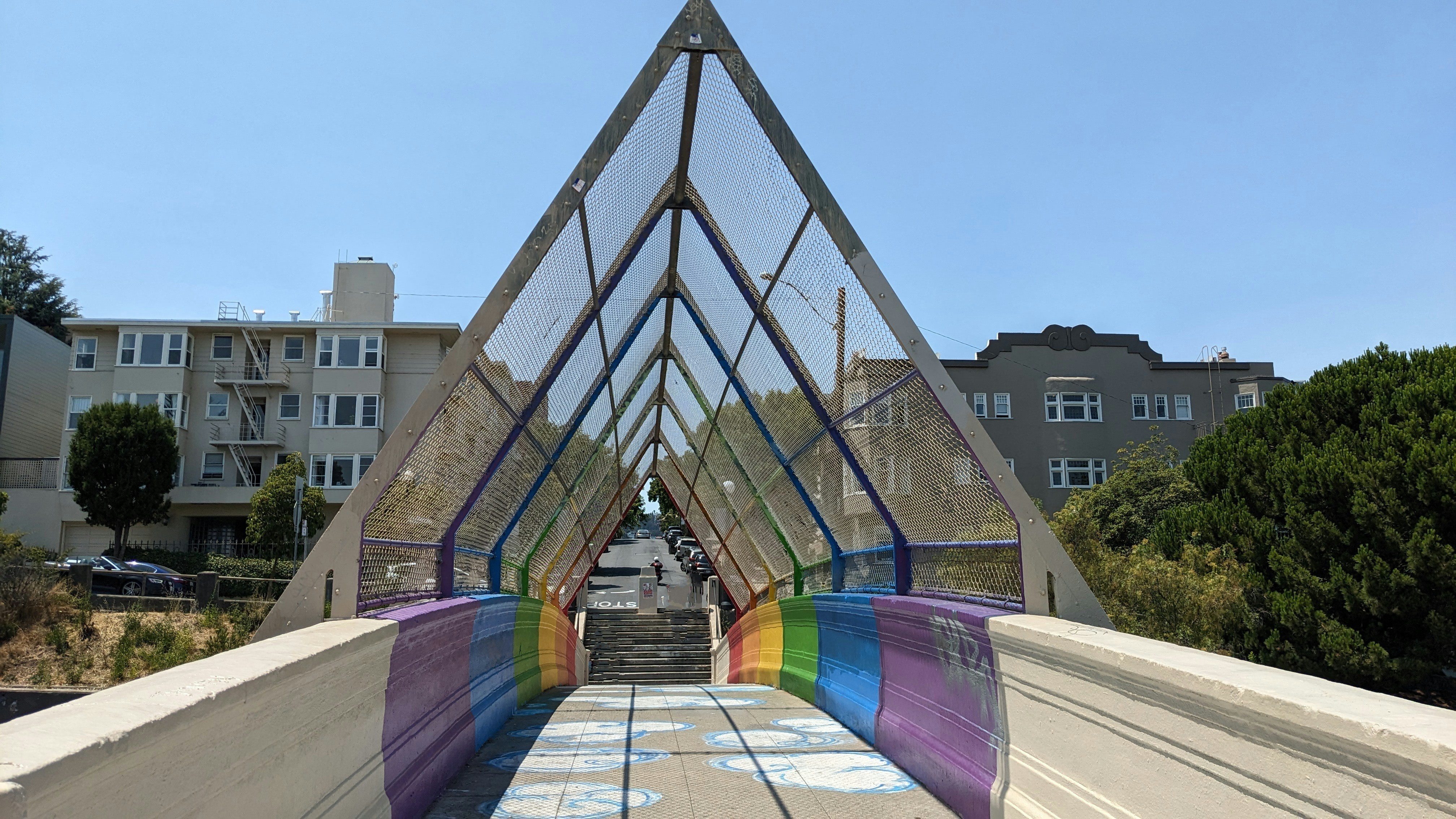 Rainbow Arch Over a Sunlit City Bridge