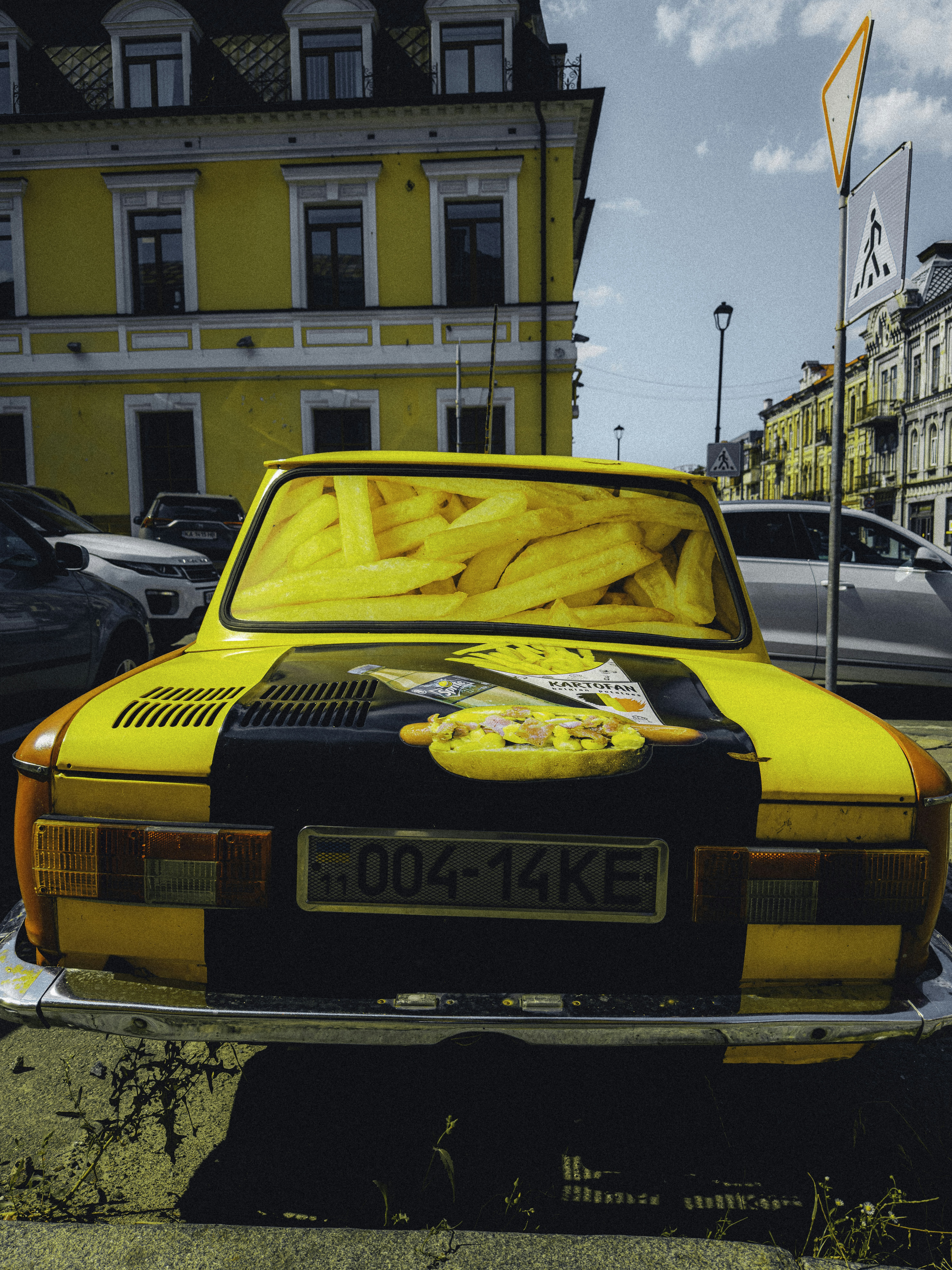 Fries in the Windshield: A Yellow Cab Stopped on a Sunlit Street