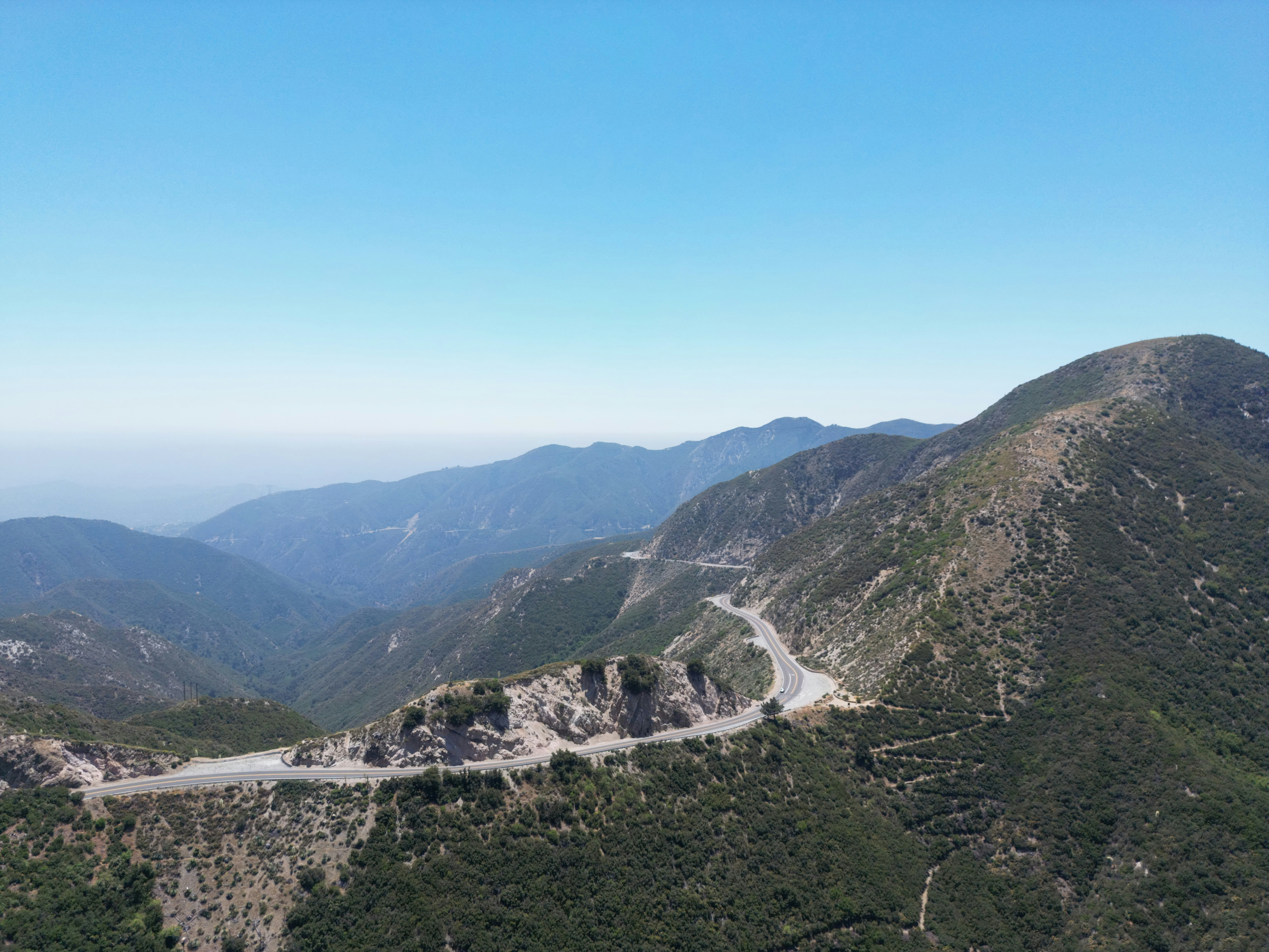Winding Crest: A Mountain Road Carves a Silent Ribbon Through Serrated Peaks