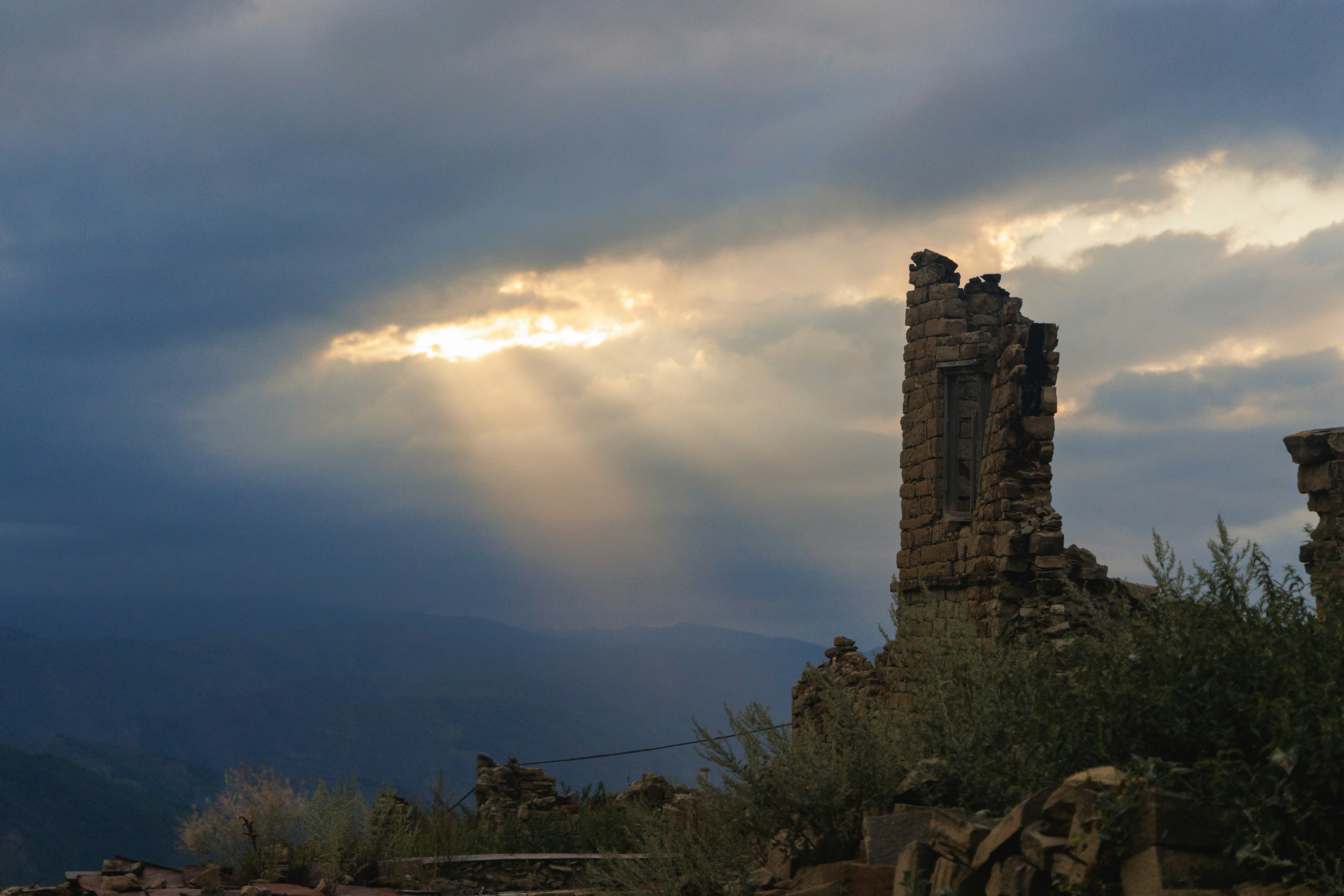 Dawn Beams Over a Weathered Ruin in the Valley
