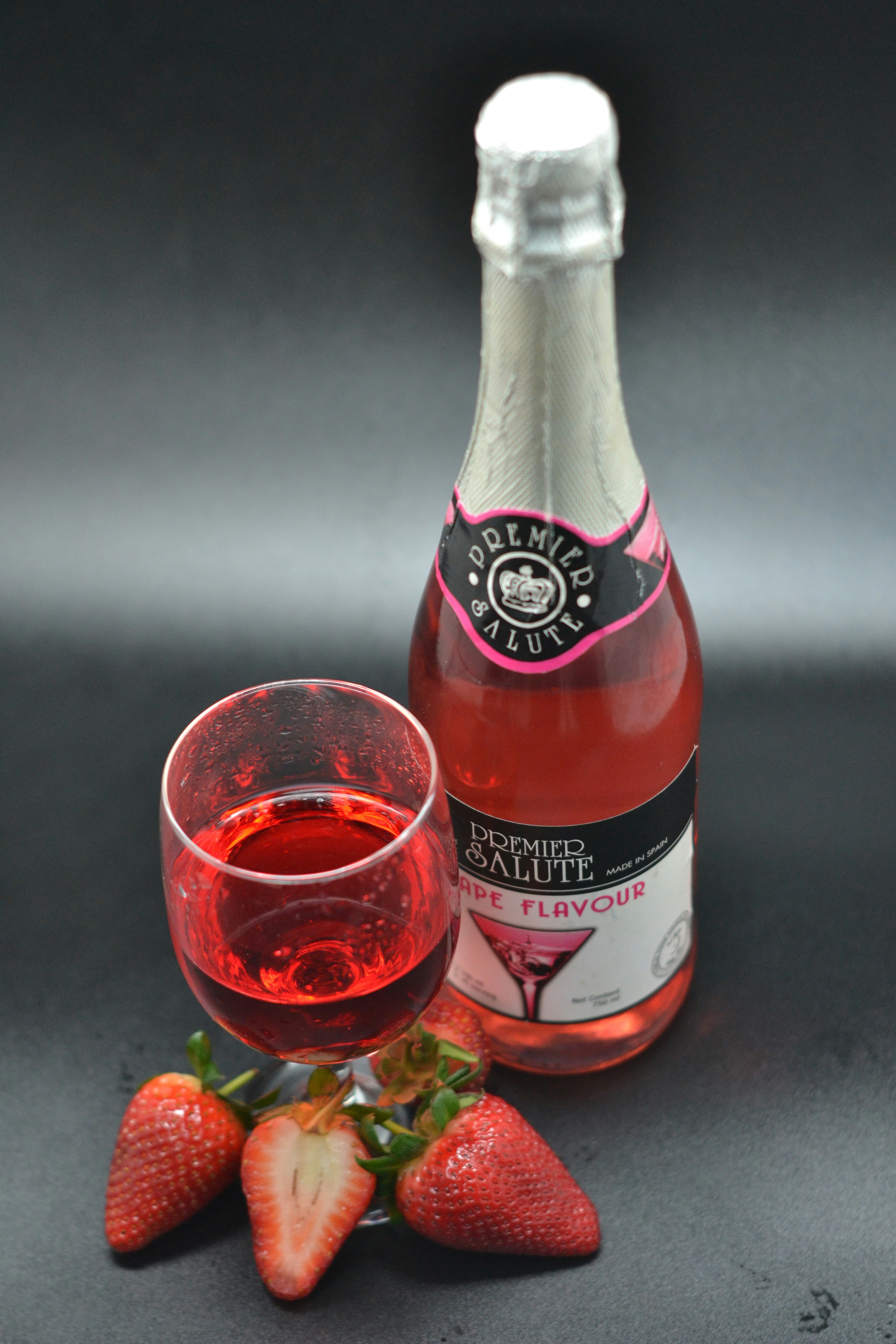 Celebration in a Bottle: A Ruby Afternoon with Straws Subtly Framing Sweetness