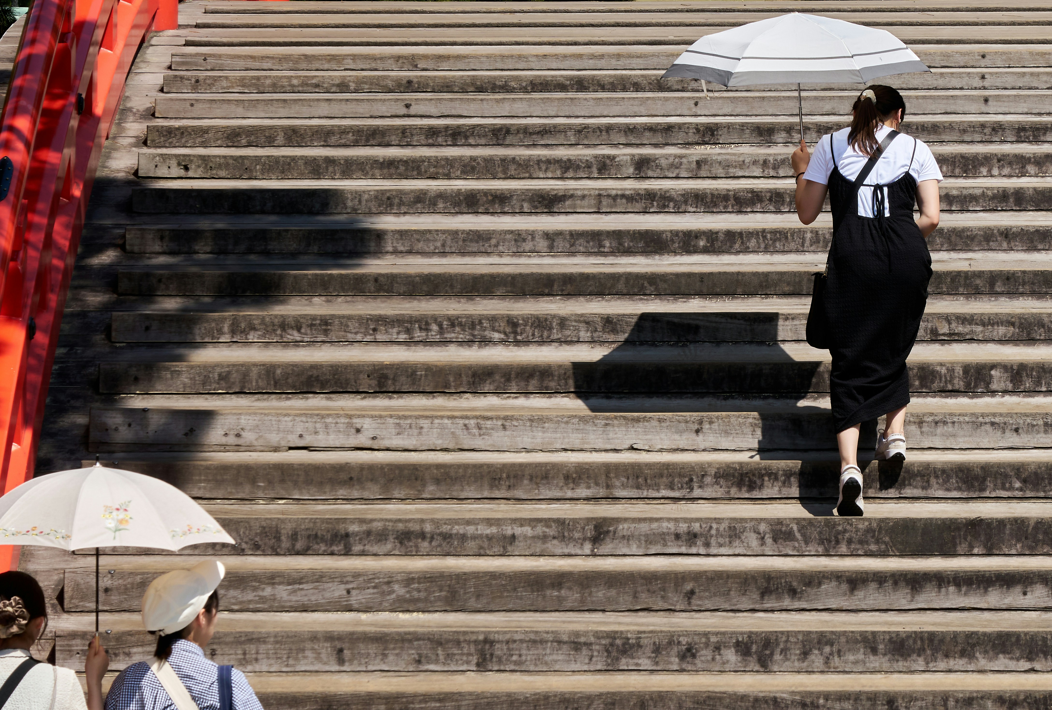 A group of people walking up some steps with umbrellas photo – Free 日本 ...