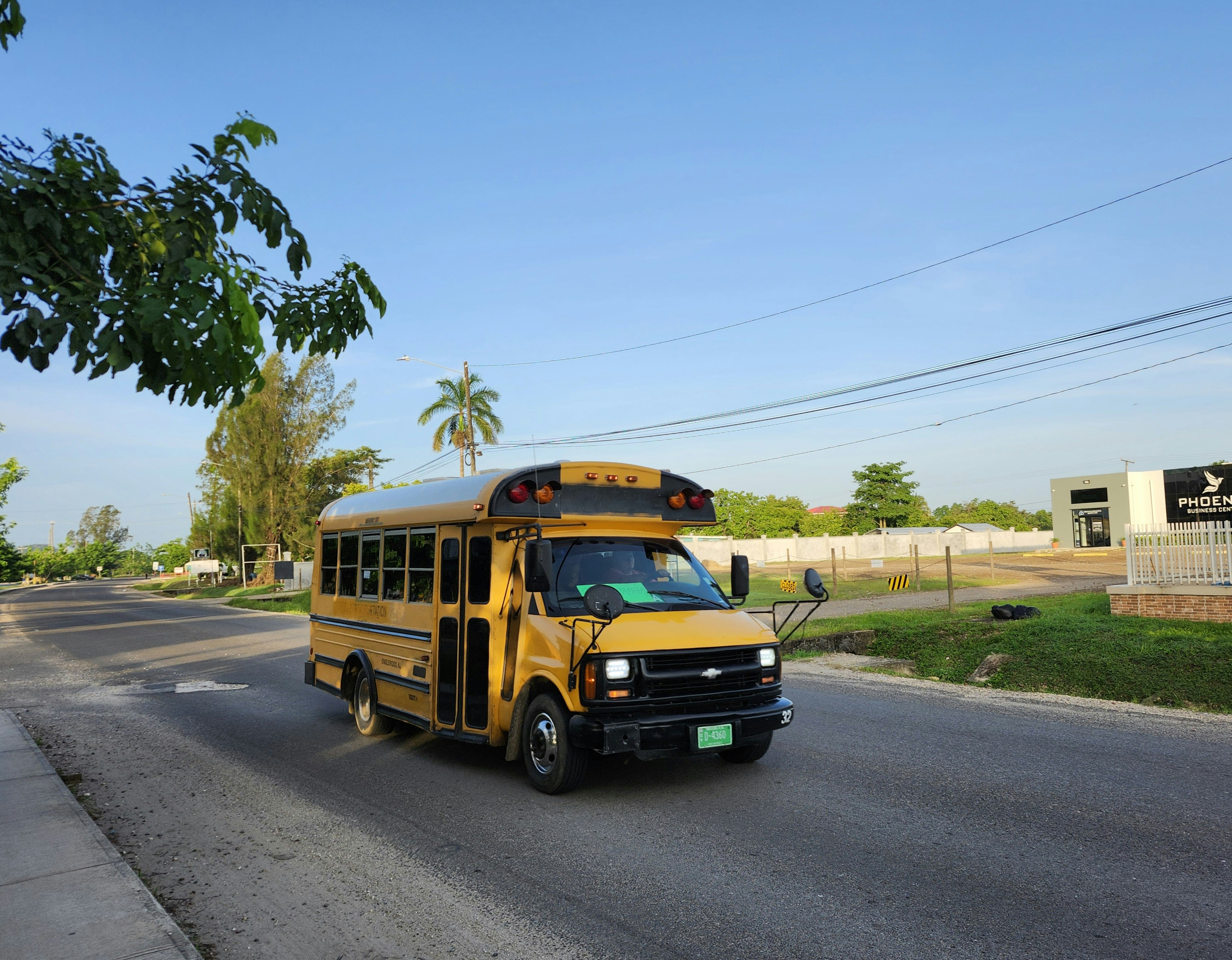 A yellow school bus driving down a street photo – Free Human Image on ...