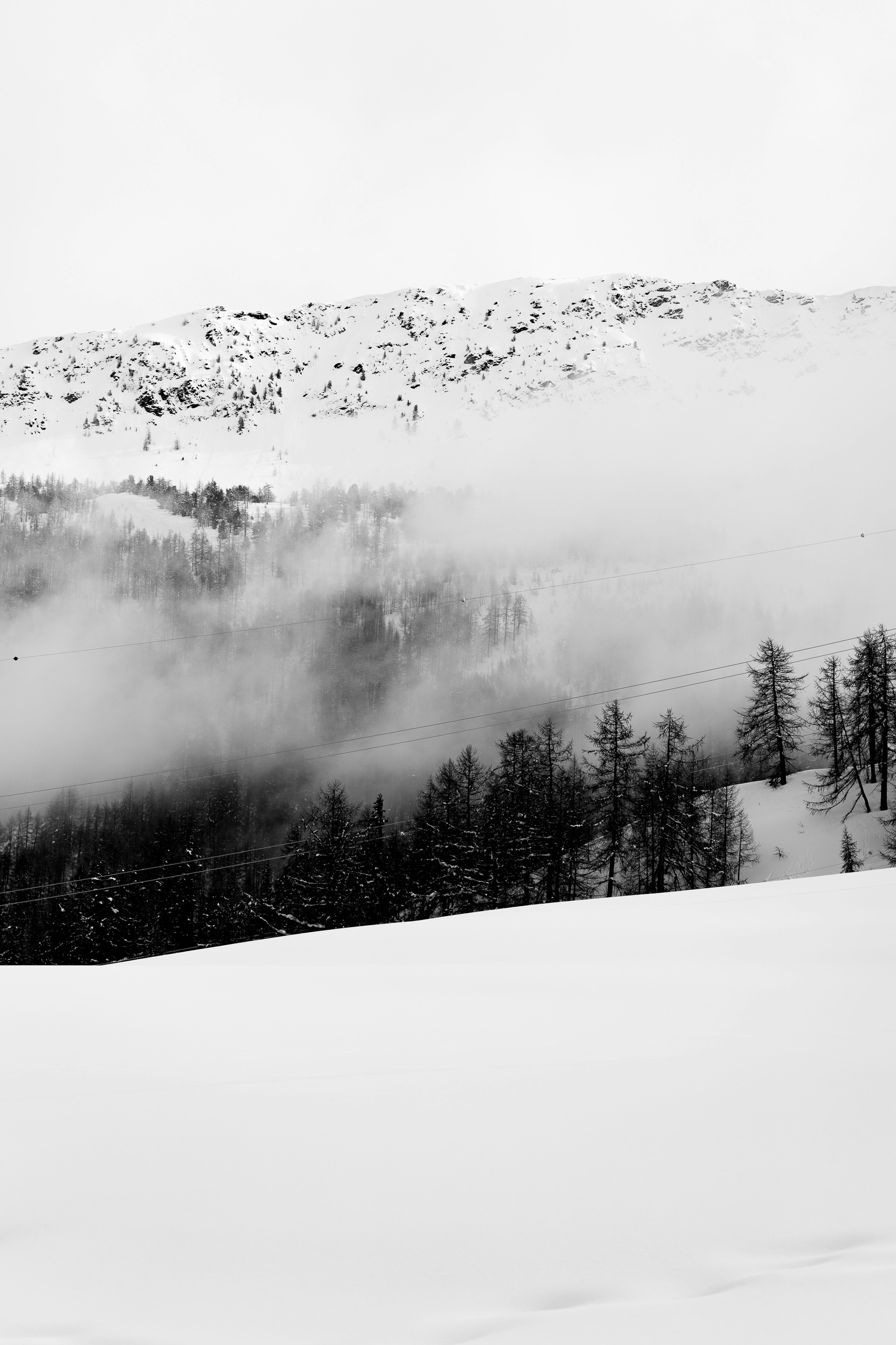 A man riding skis on top of a snow covered slope