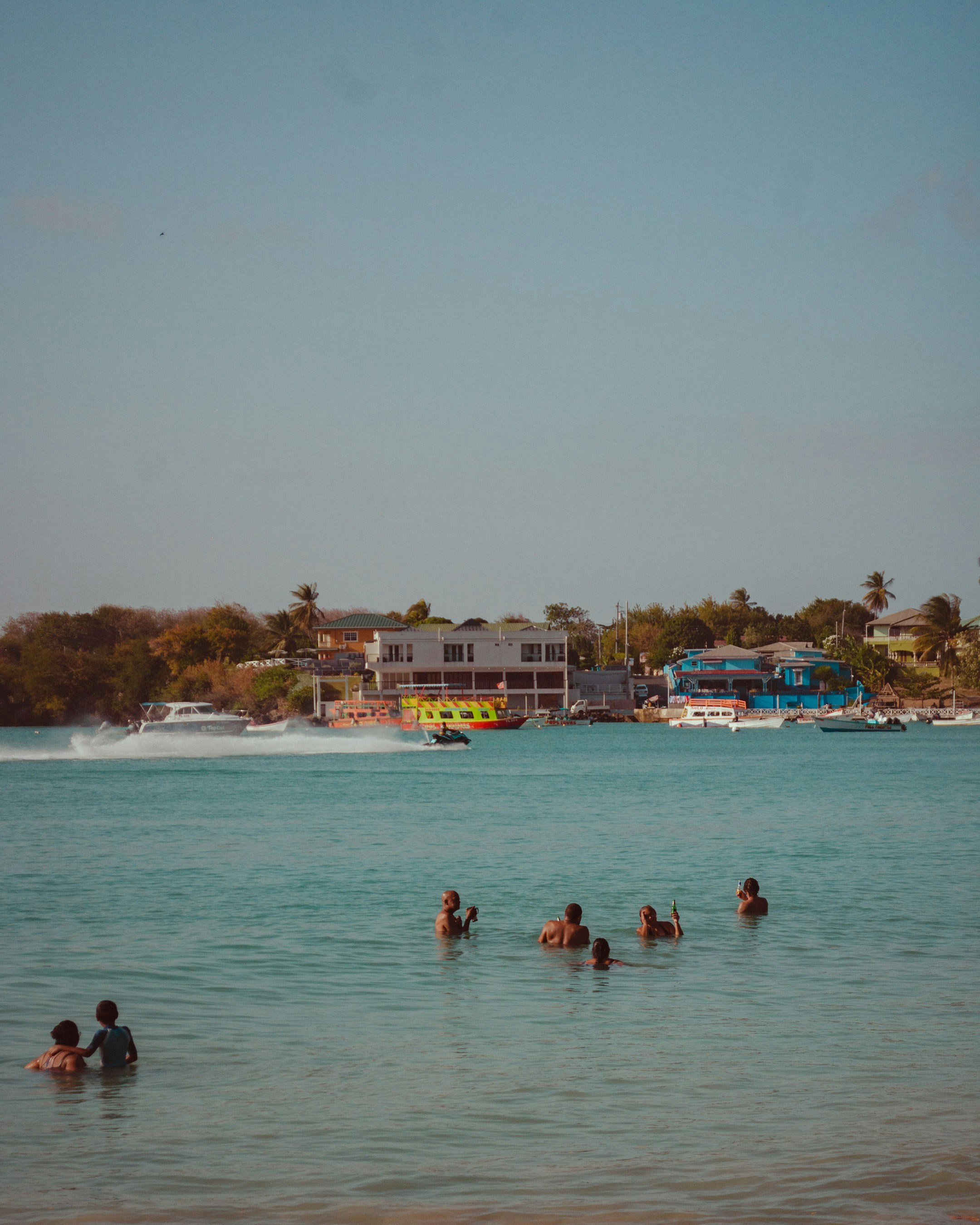 A group of people swimming in a body of water photo – Free Vacation ...