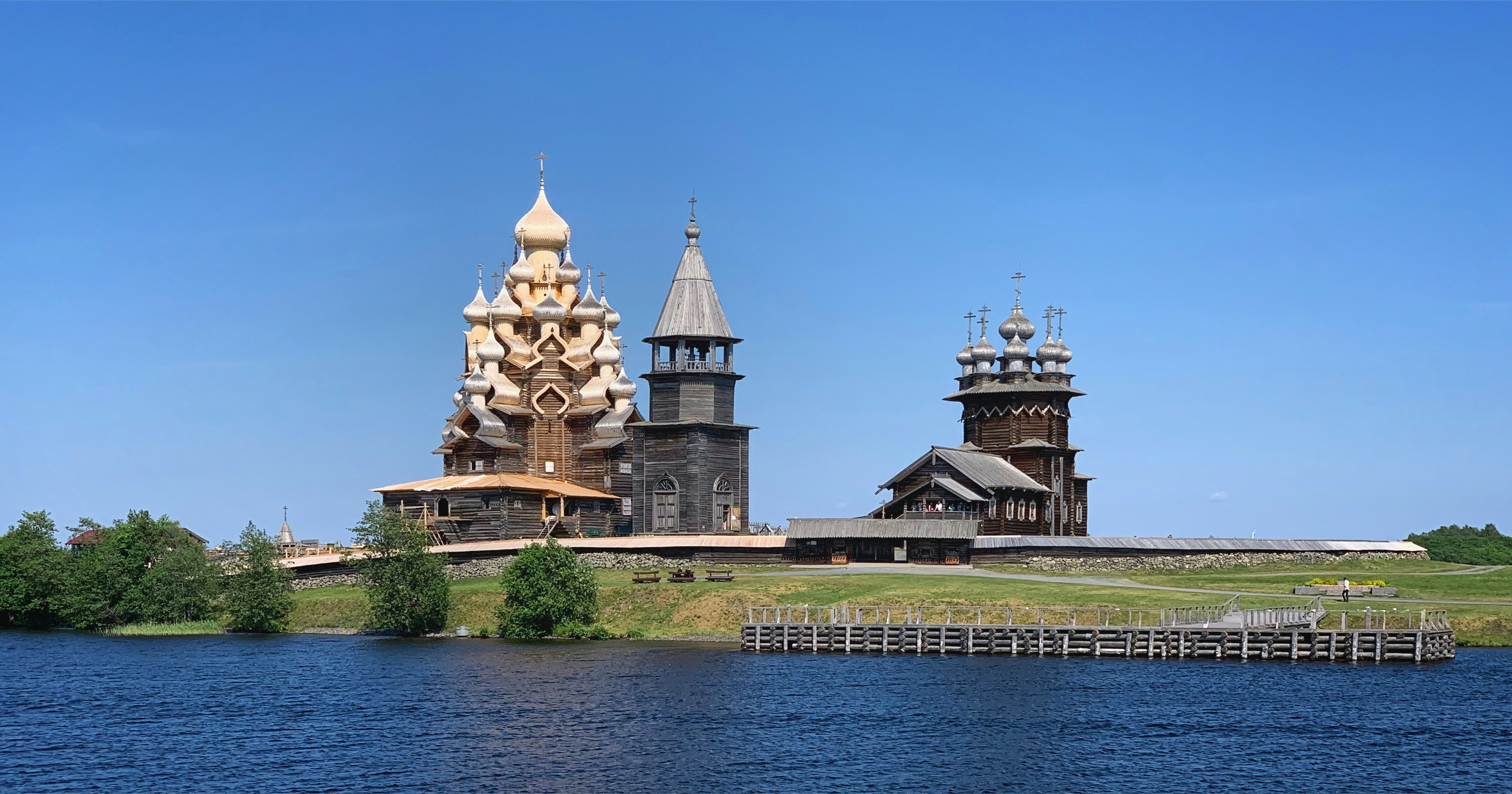 Fortress on the Waterfront: Wooden Spires Against a Clear Horizon