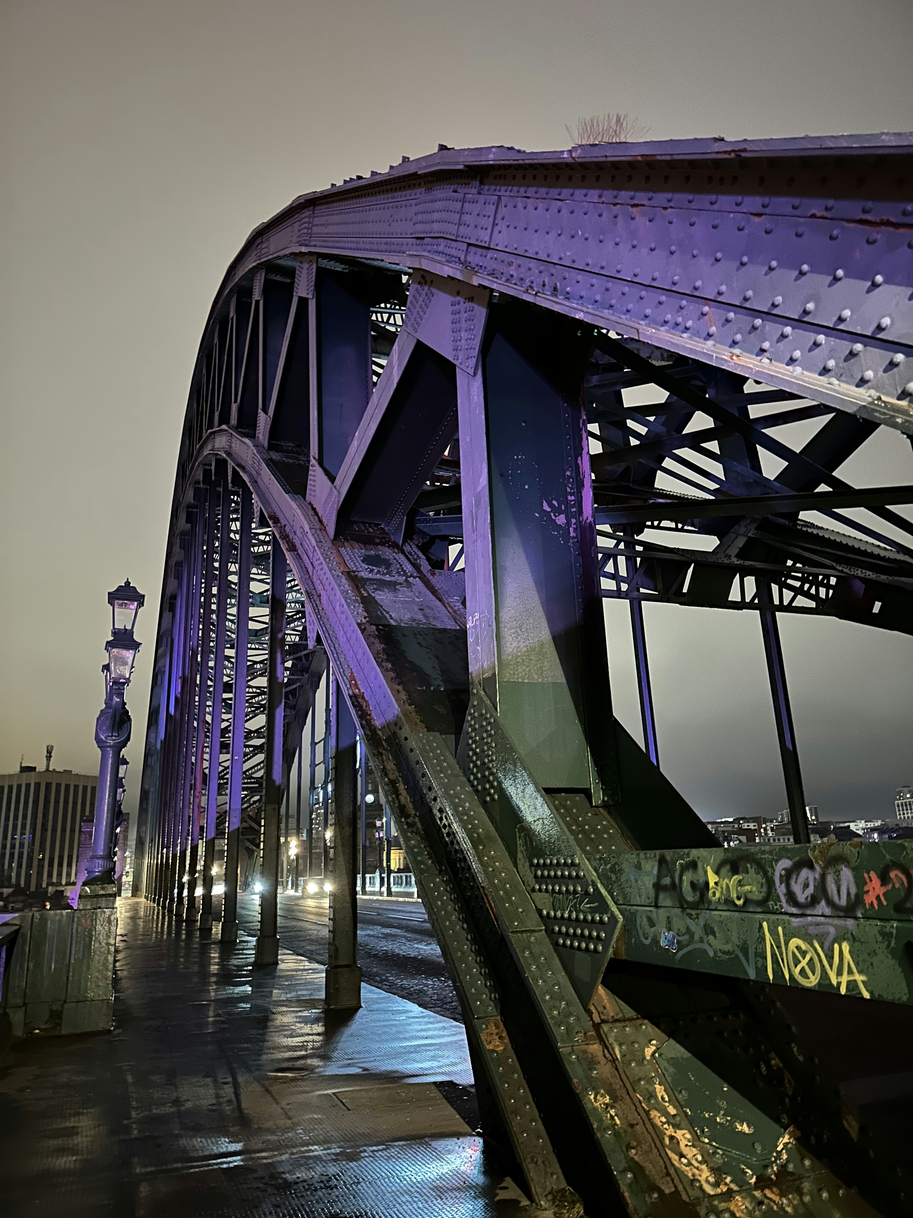 Nocturnal Violet Arc: a rain-kissed bridge under city glow