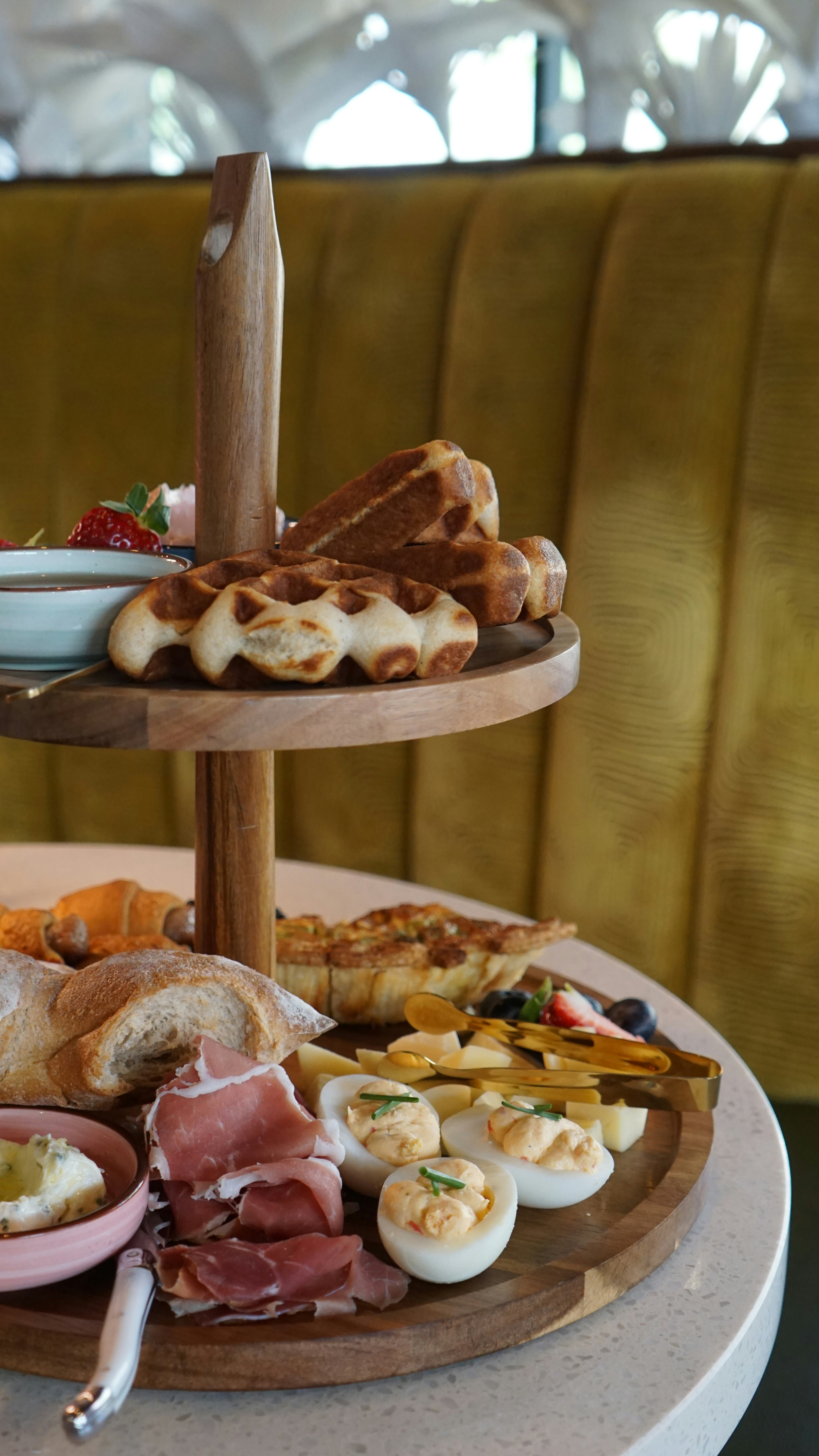 Tiered Platter of Bread, Cheese, and Prosciutto on a Round Lazy Susan