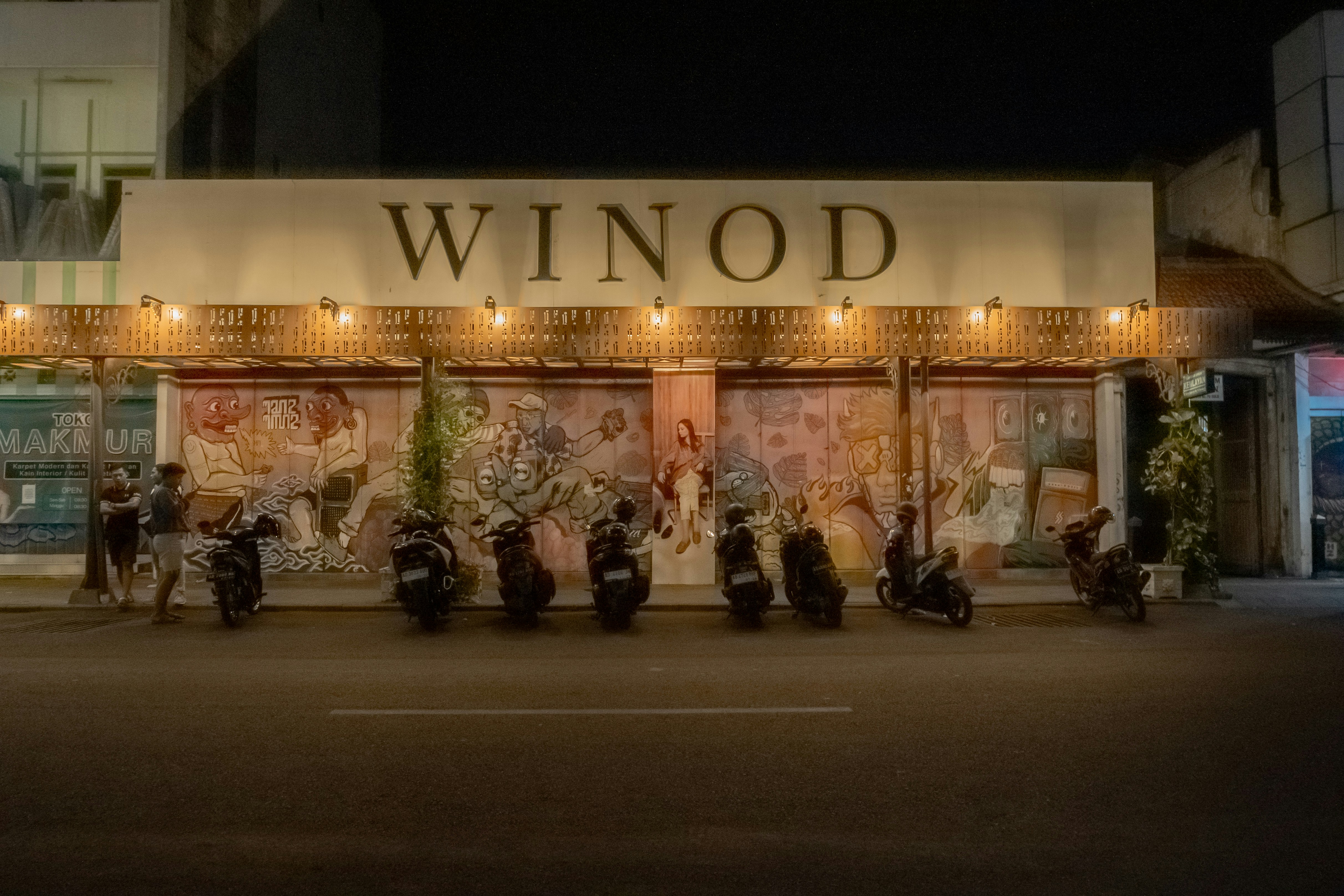 A row of motorcycles parked in front of a building photo – Free Winod ...
