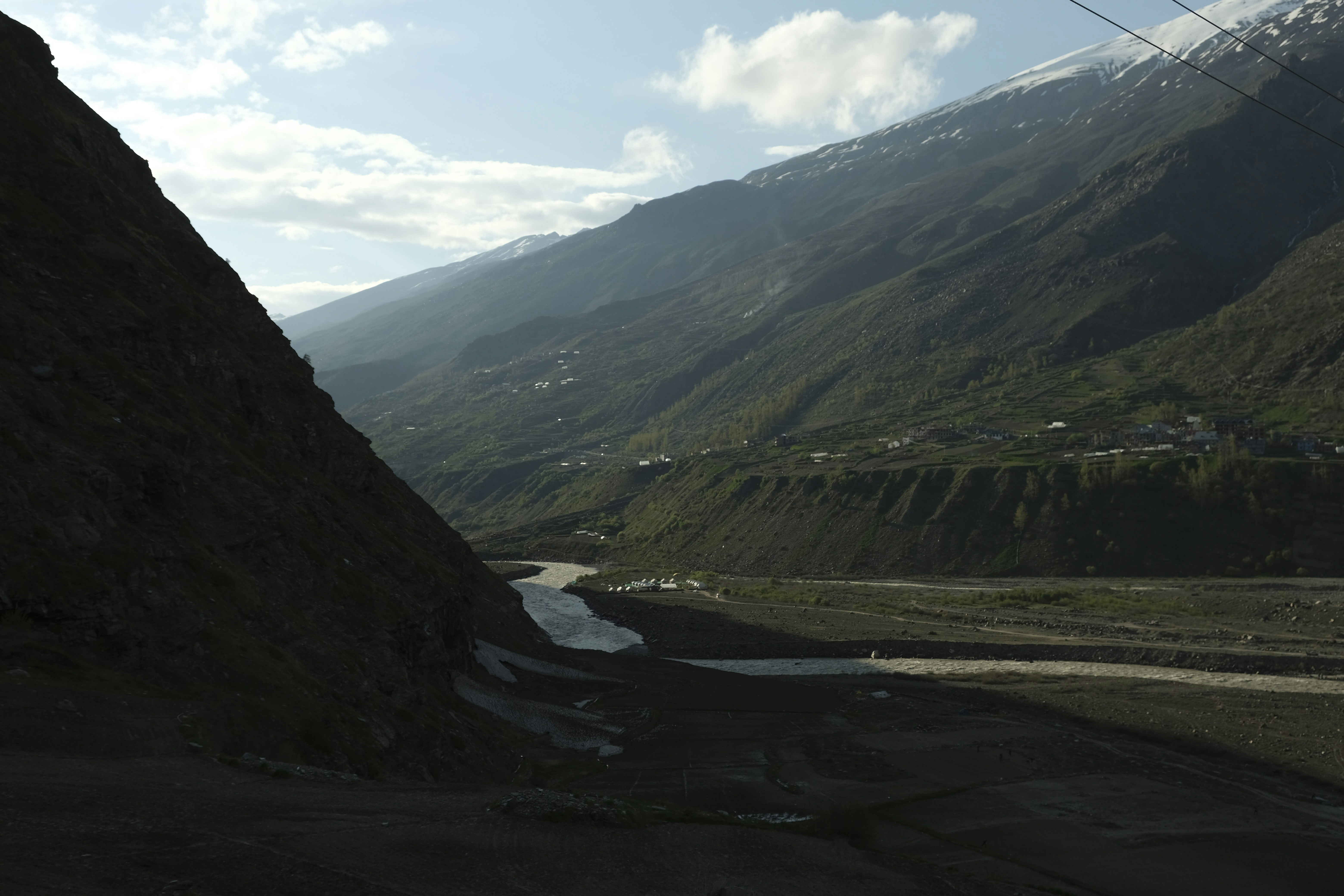 Chiaroscuro Gorge: A Narrow River Wends Between Snow-Dusted Slopes