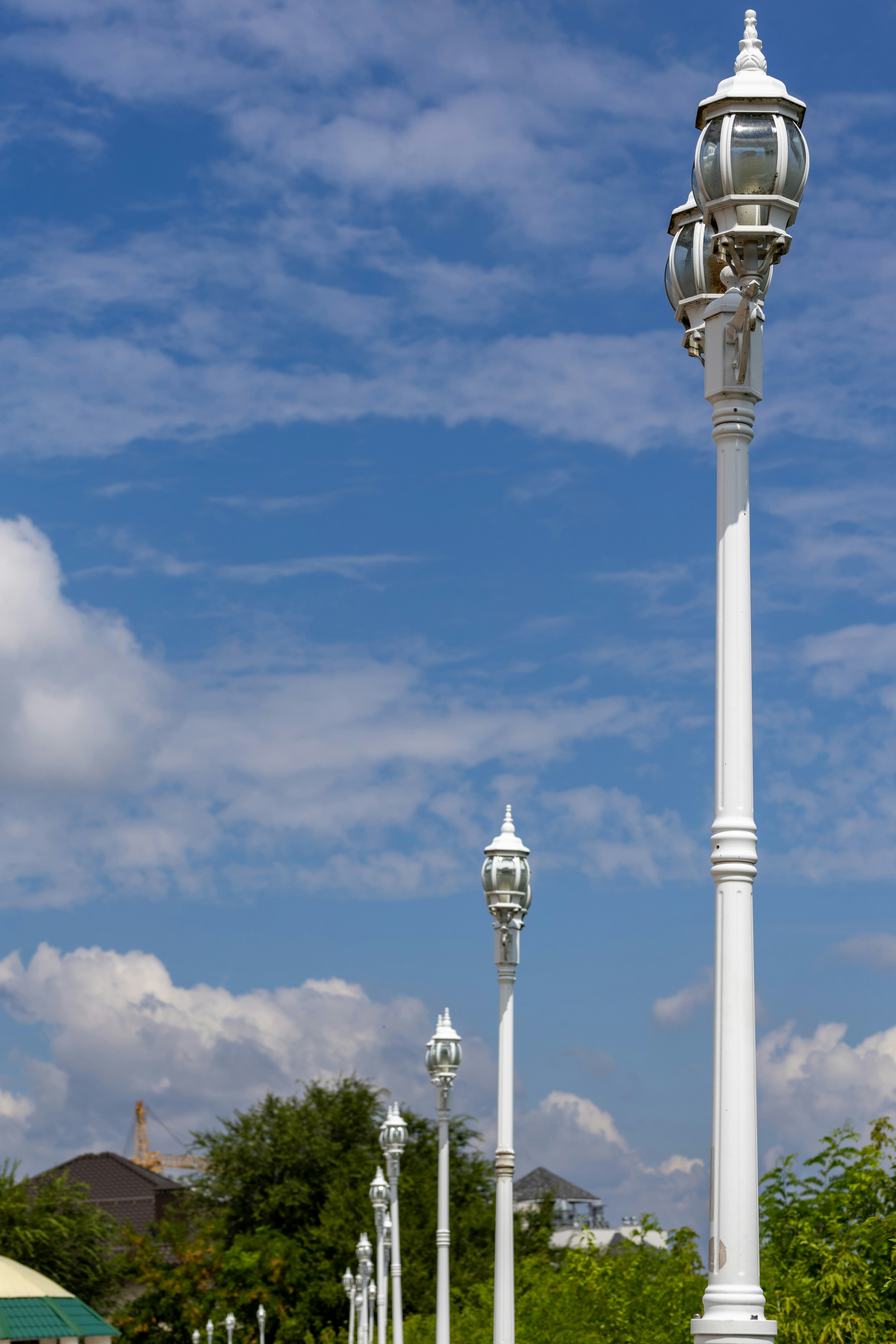 Lantern Line Along a Sunlit Street Under a Cerulean Sky