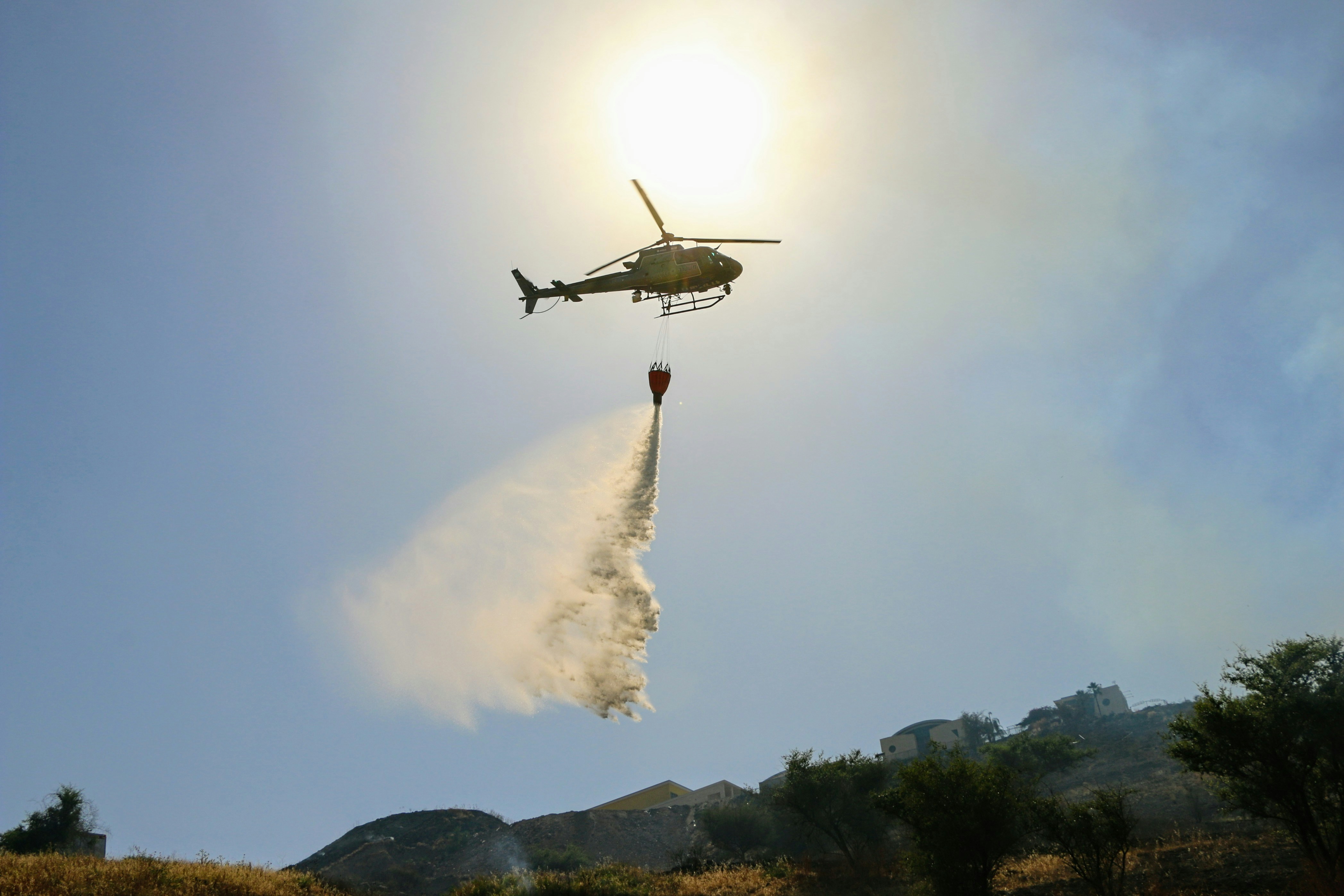 A helicopter drops water on a fire hydrant photo – Free Animal Image on ...